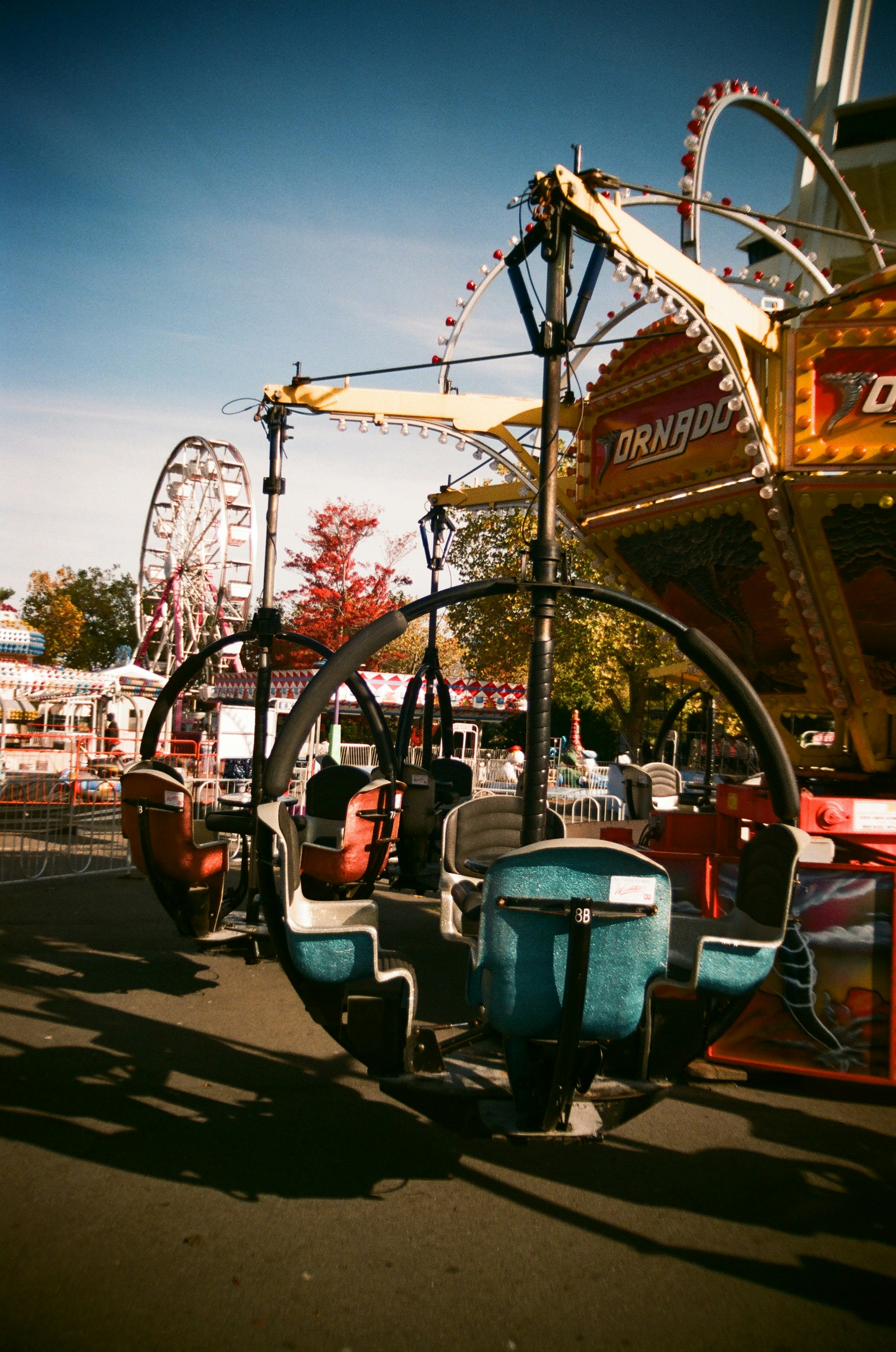Circular Ride Cars on a Sunny Carnival Floor