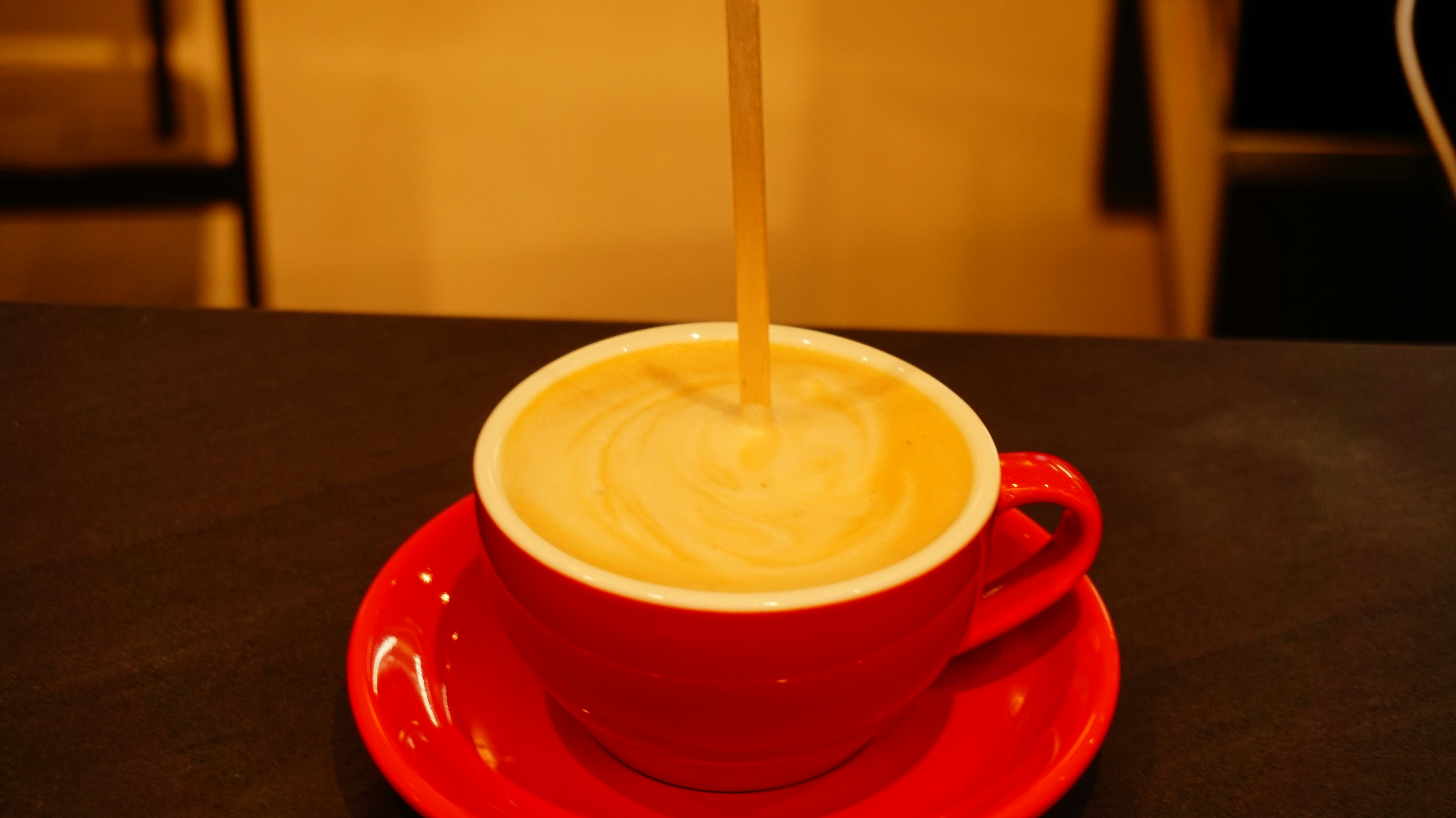 Red Cup of Latte: Swirl of Milk in a Cozy Café