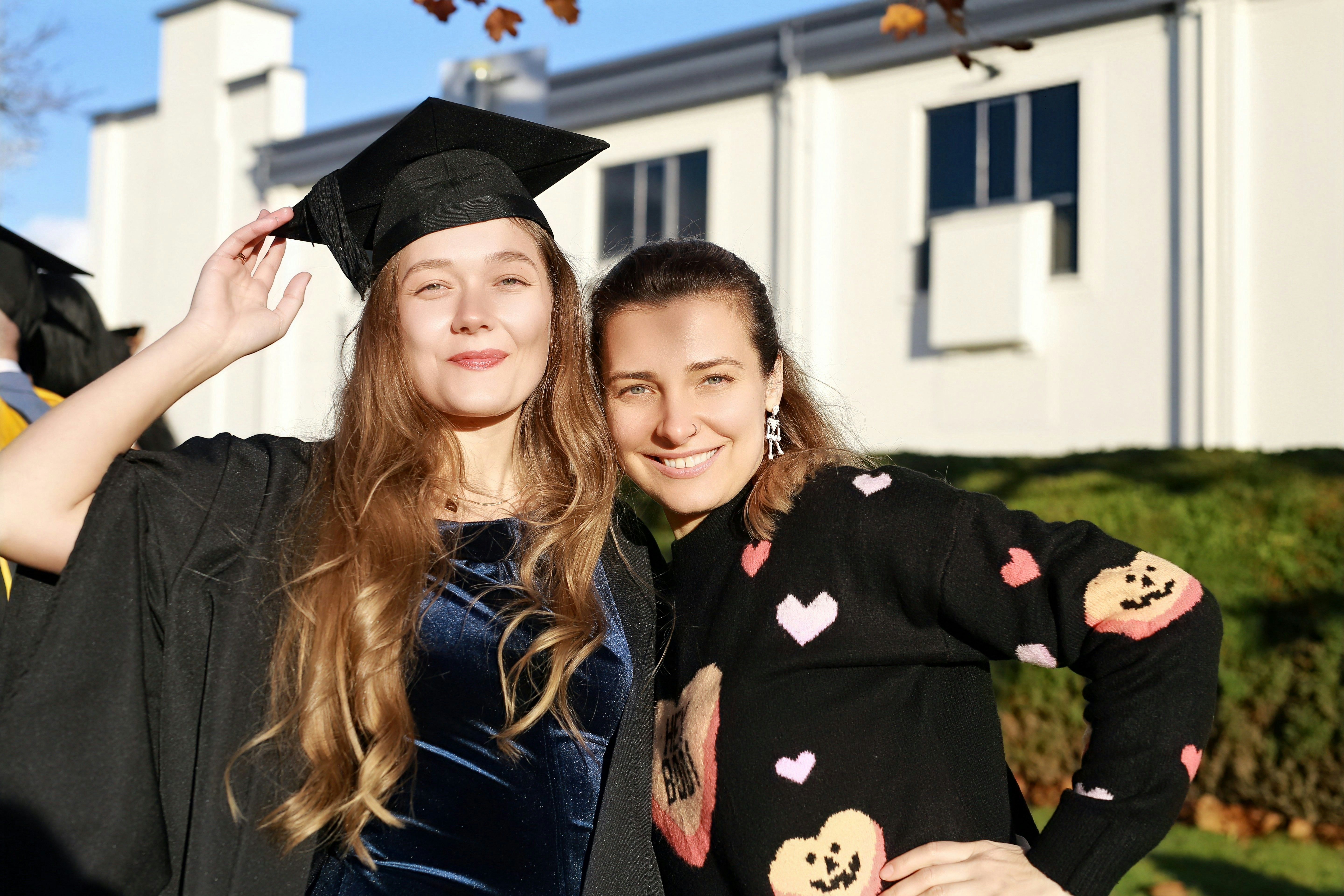 Graduation Glance: Shared Smile Under Sunshine