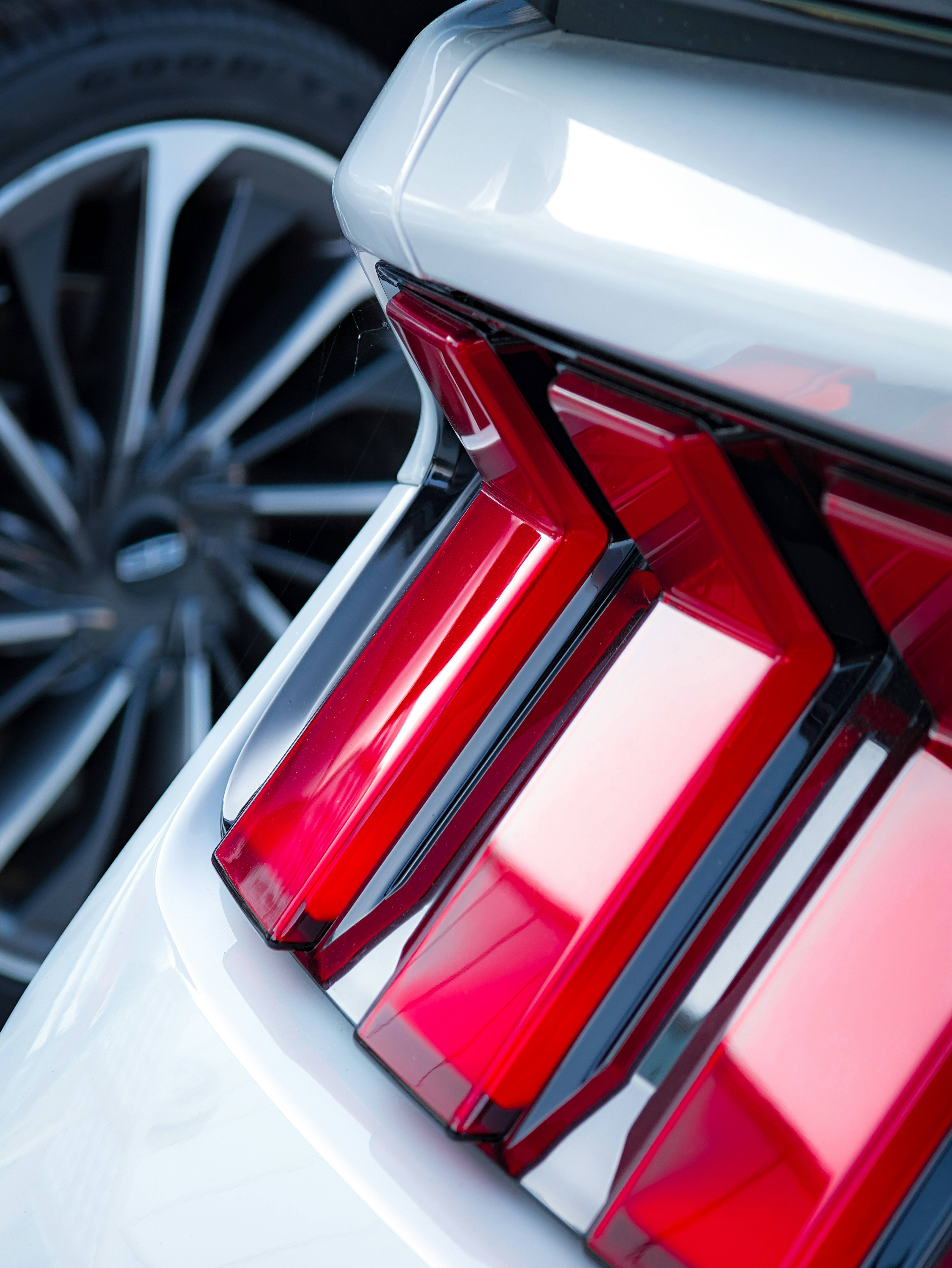 Redline Reflections: Tail Light Geometry on a White Contour