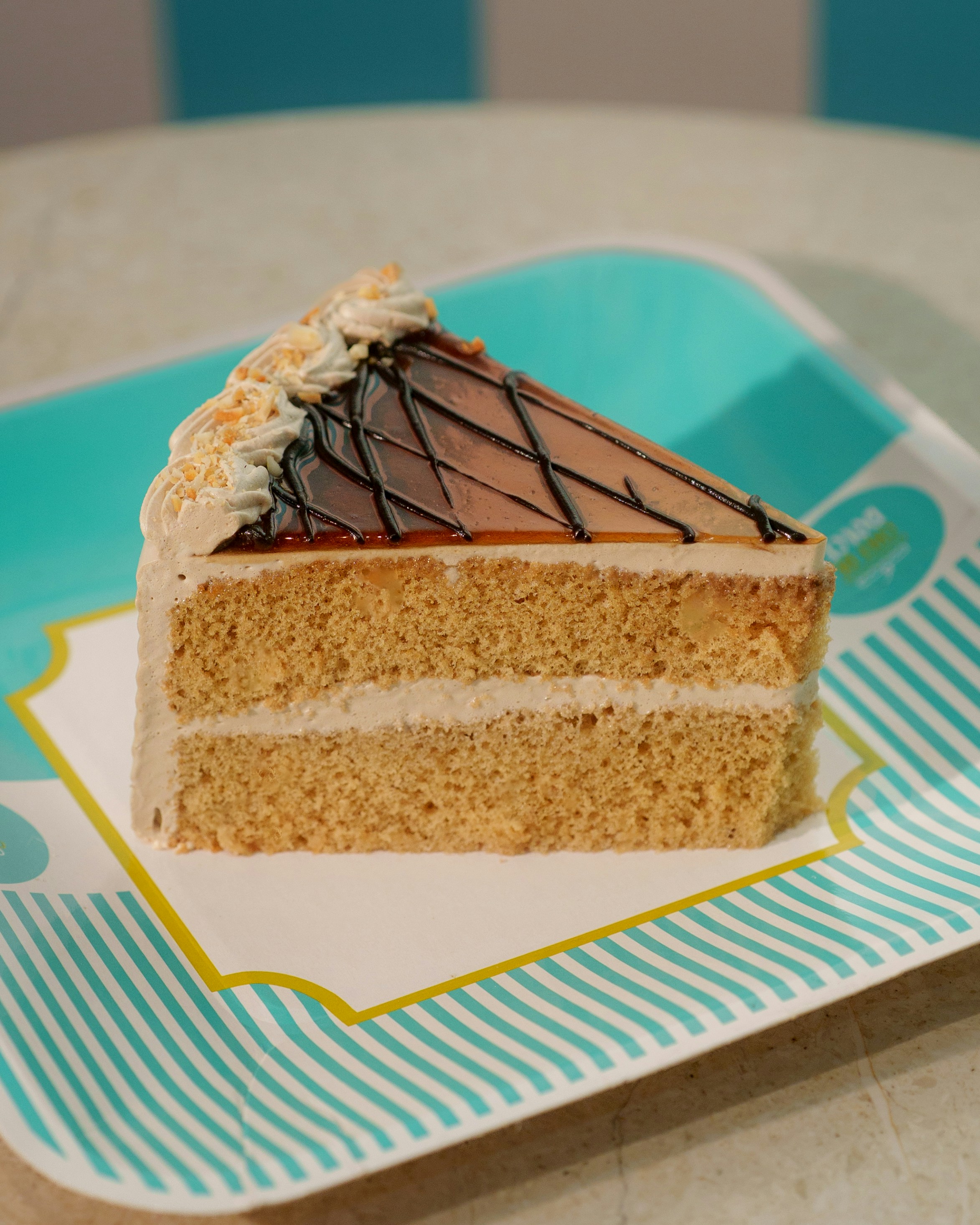 Slice of Caramel Cloud: A Duo-Tier Cake on a Geometric Plate