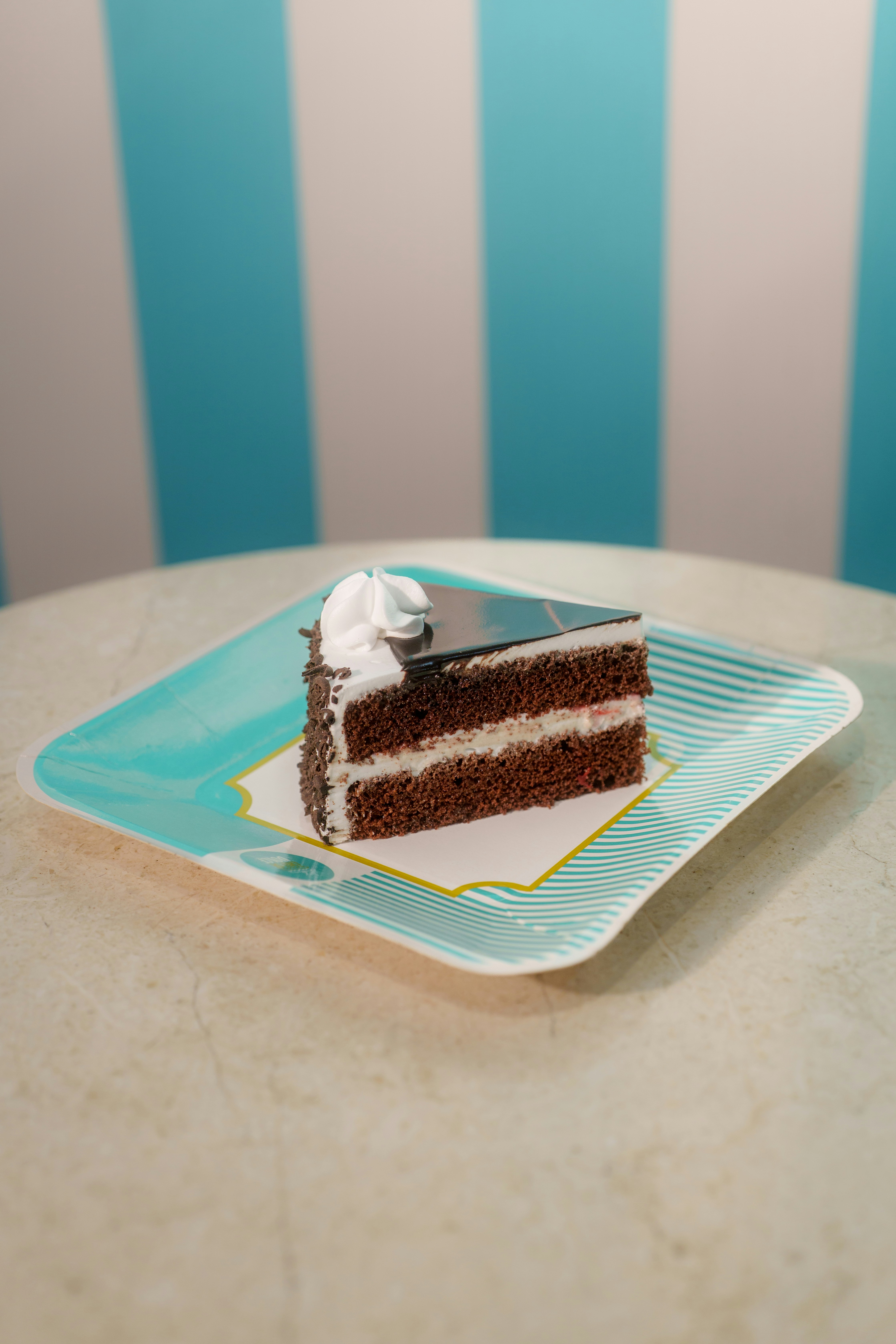 Slice of Velvet Chocolate: A Midnight Tiered Cake on a Retro Plate