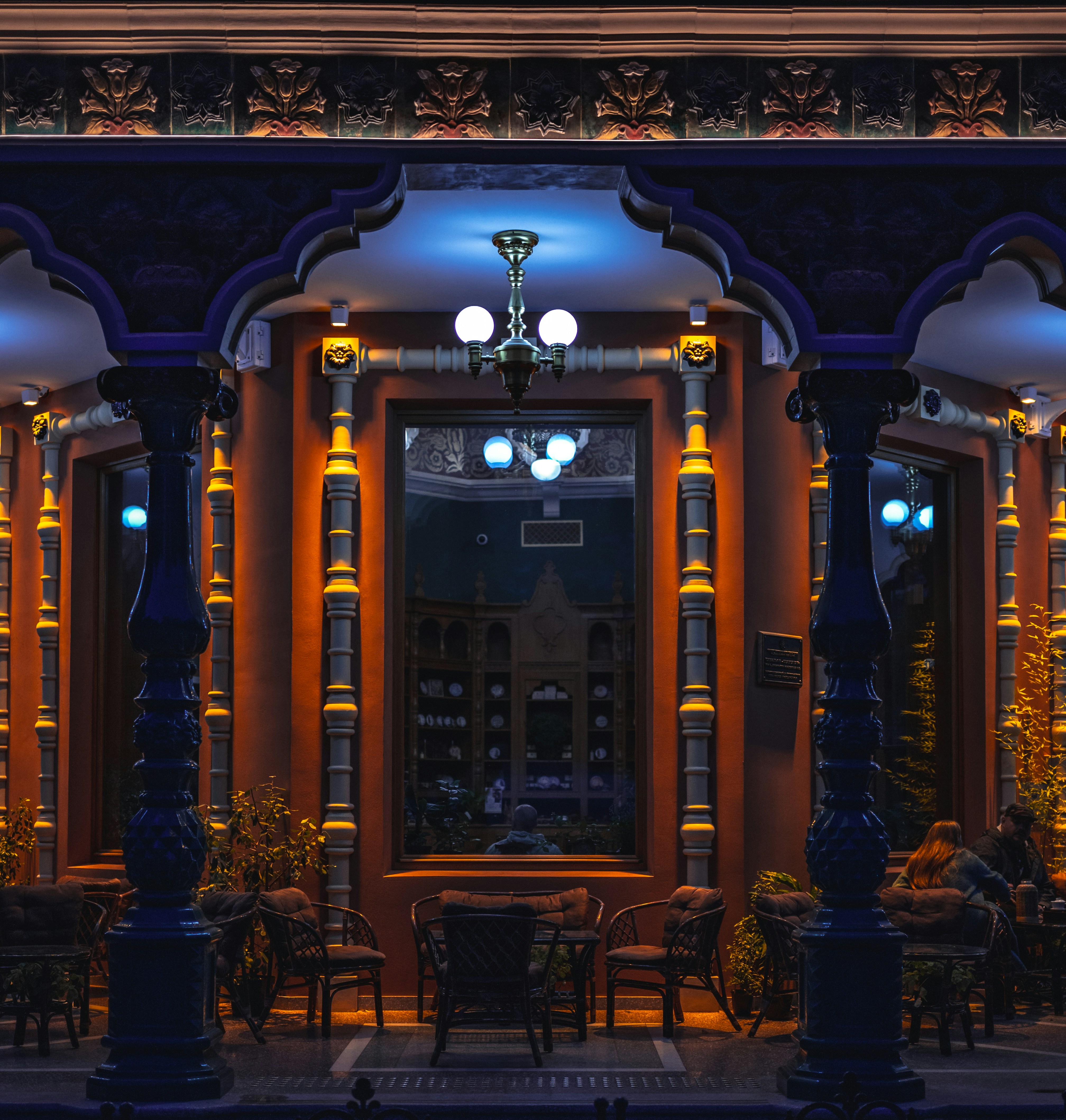 Midnight Courtyard Bistro: Neon Light Through Carved Archways