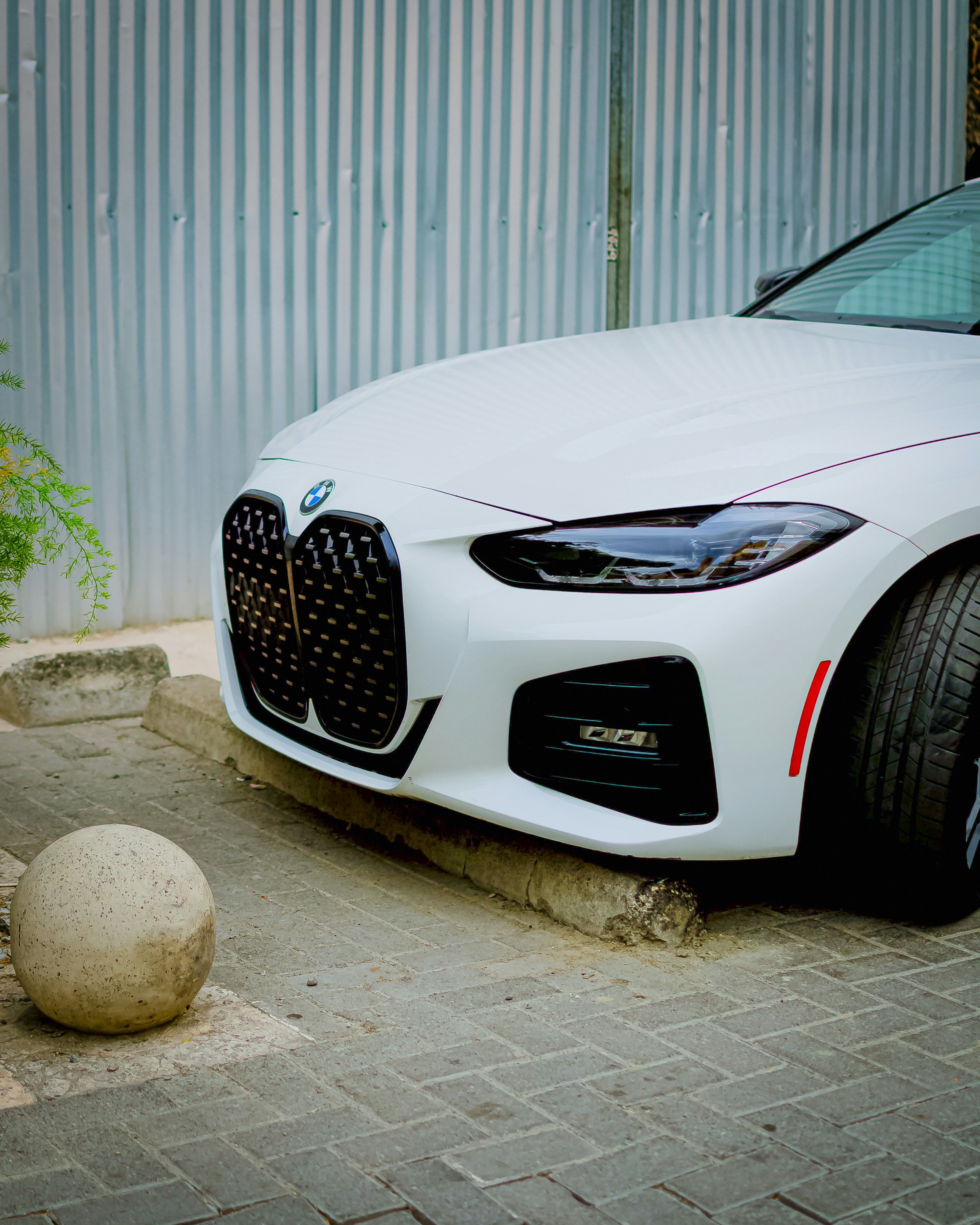 White BMW Stance: Corner, Chrome Grille, and Urban Texture