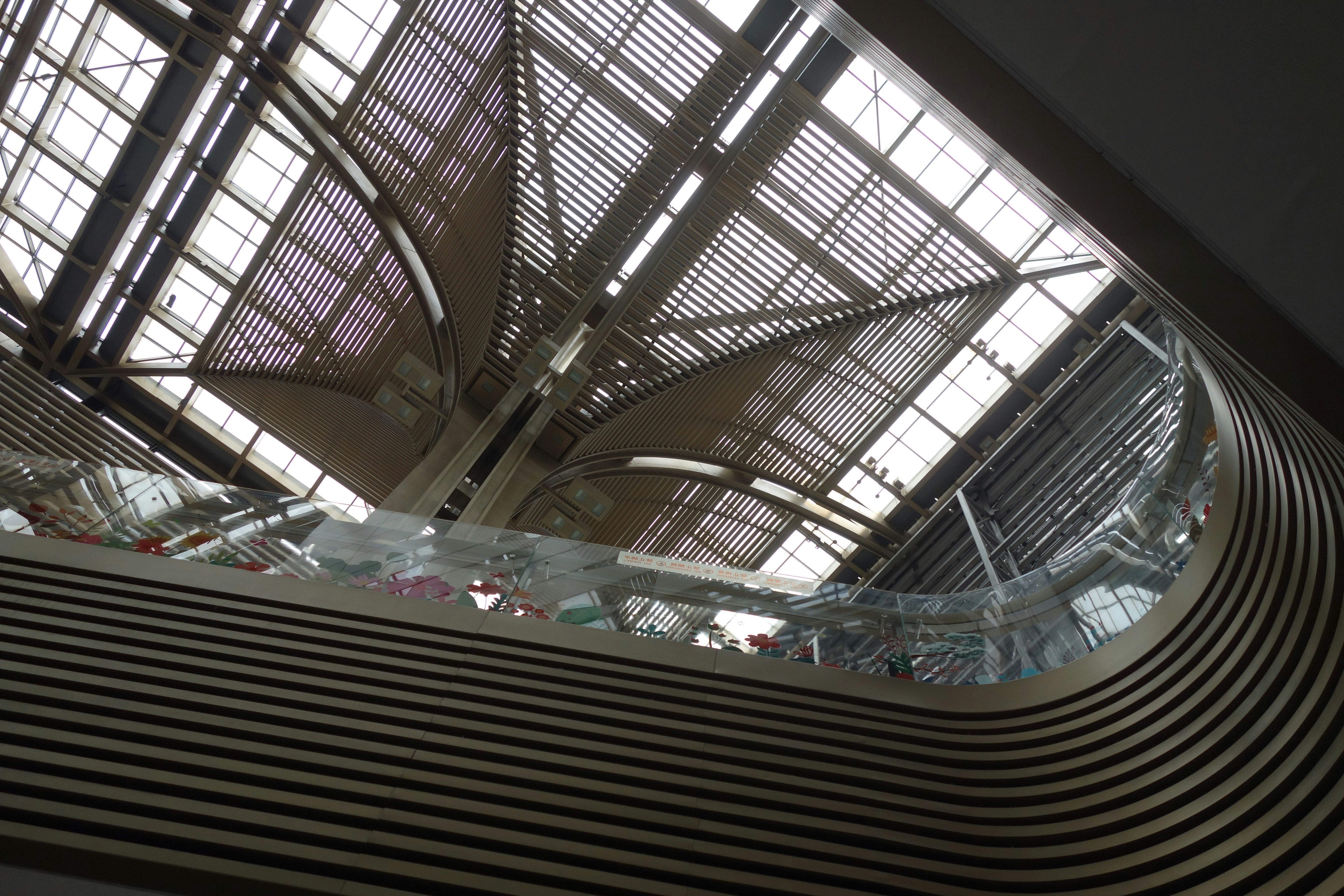 Architectural Ribbon: Curved Strata Framing a Glass Atrium