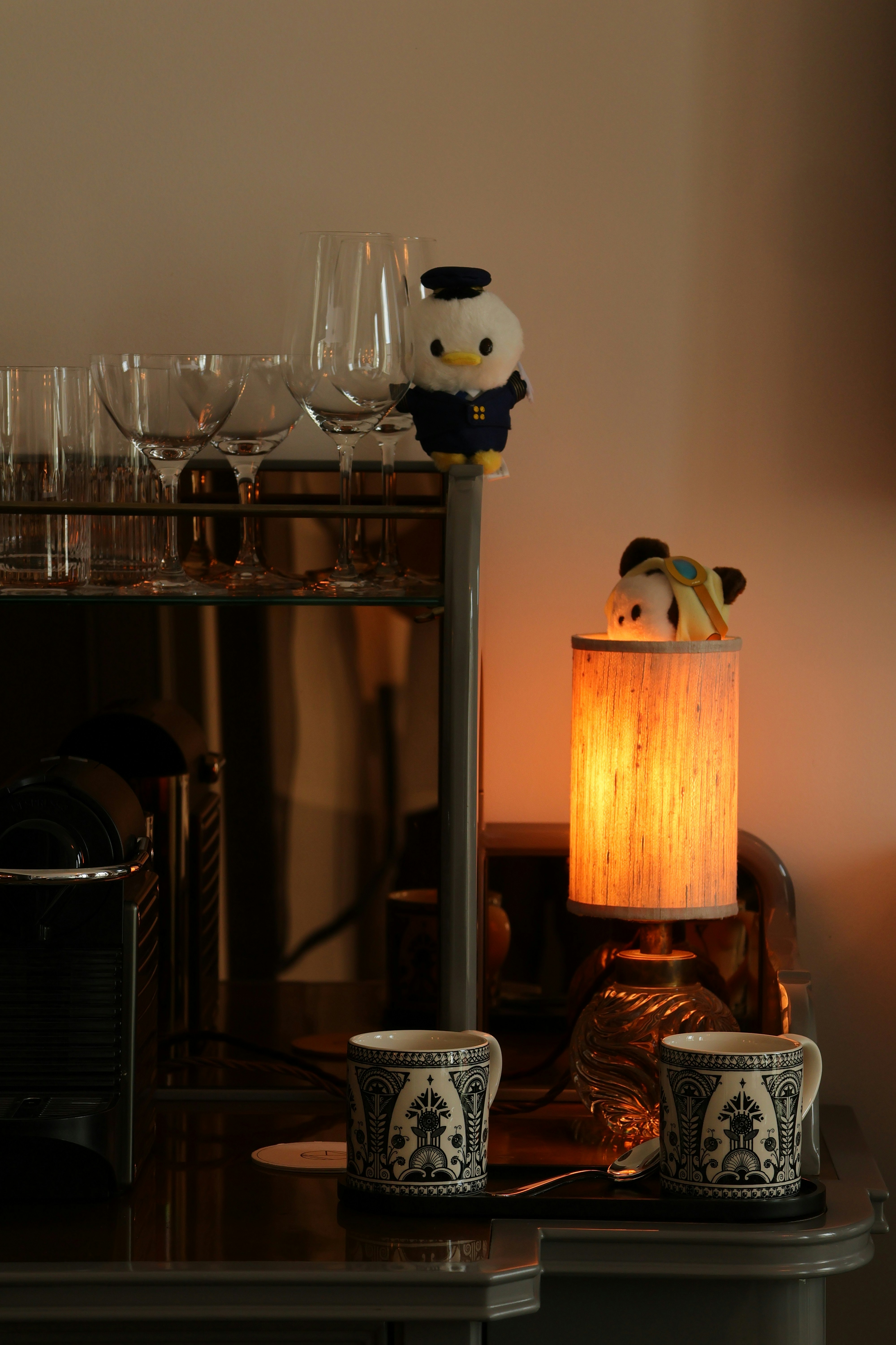 Whimsy by the Lamp: Plush Aviators Keep Watch Over a Cozy Bar Scene