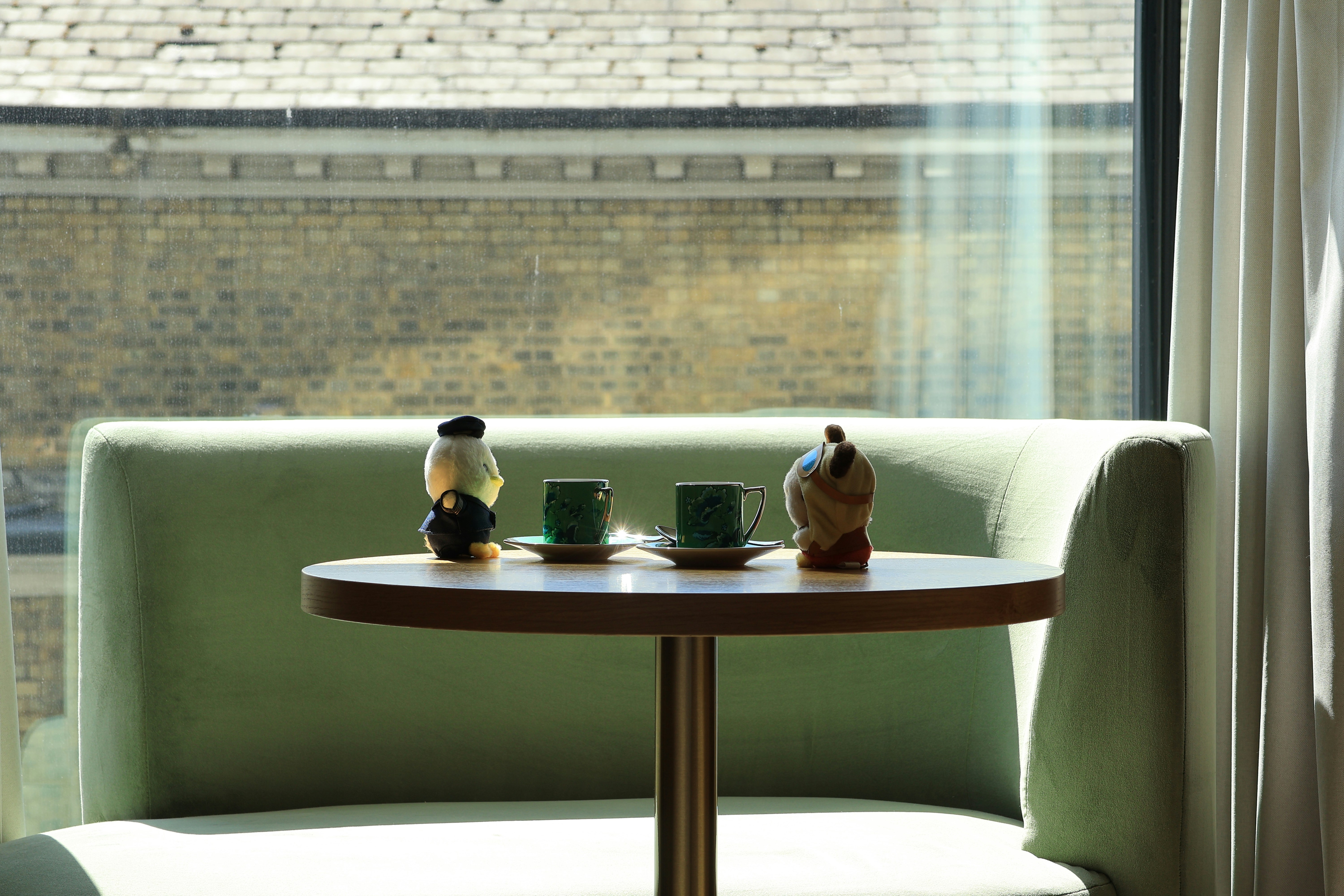 Teacups and Tiny Figures on a Calm Café Table