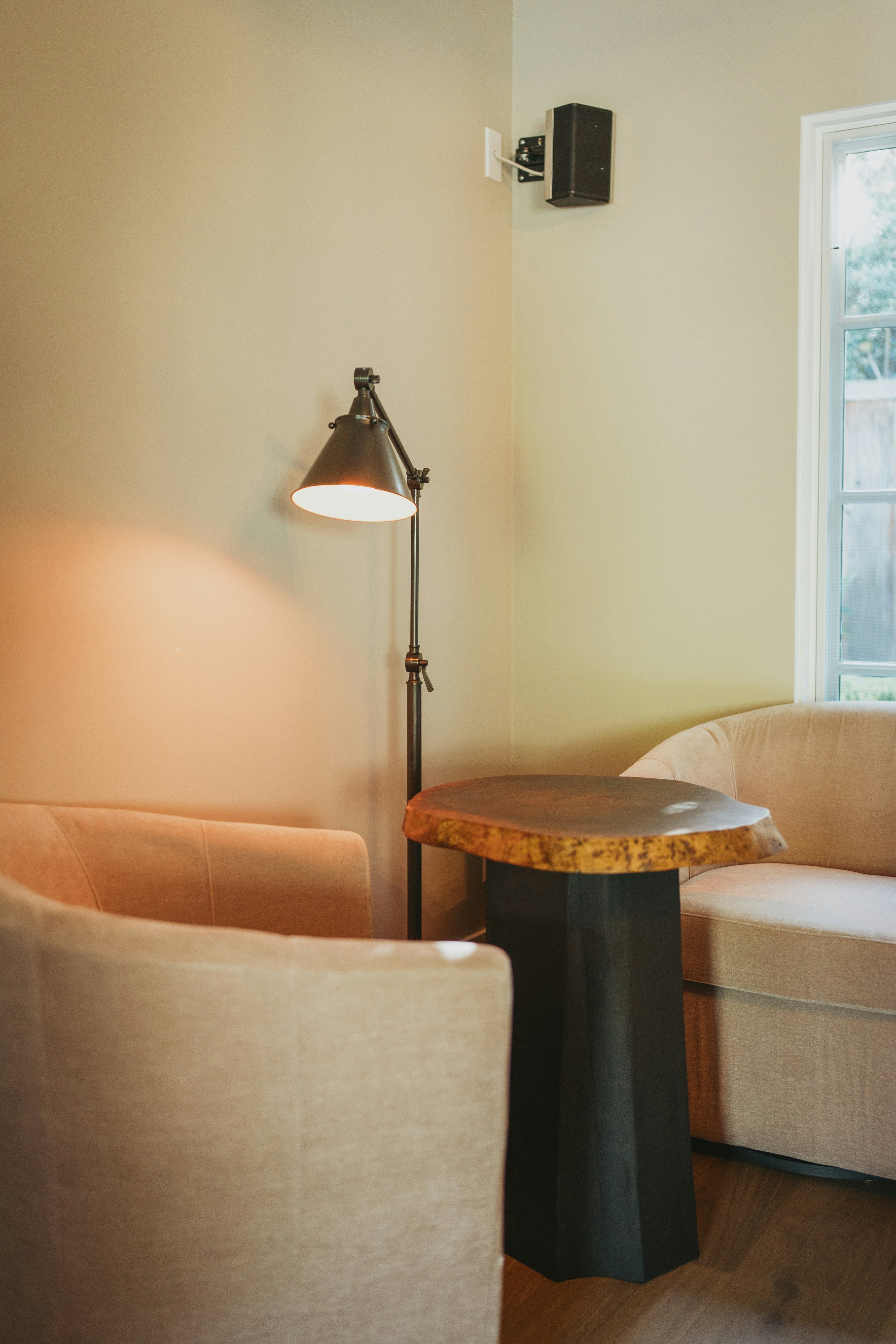 Cozy Corner: Warm Lamp, Round Table, and Soft Seating