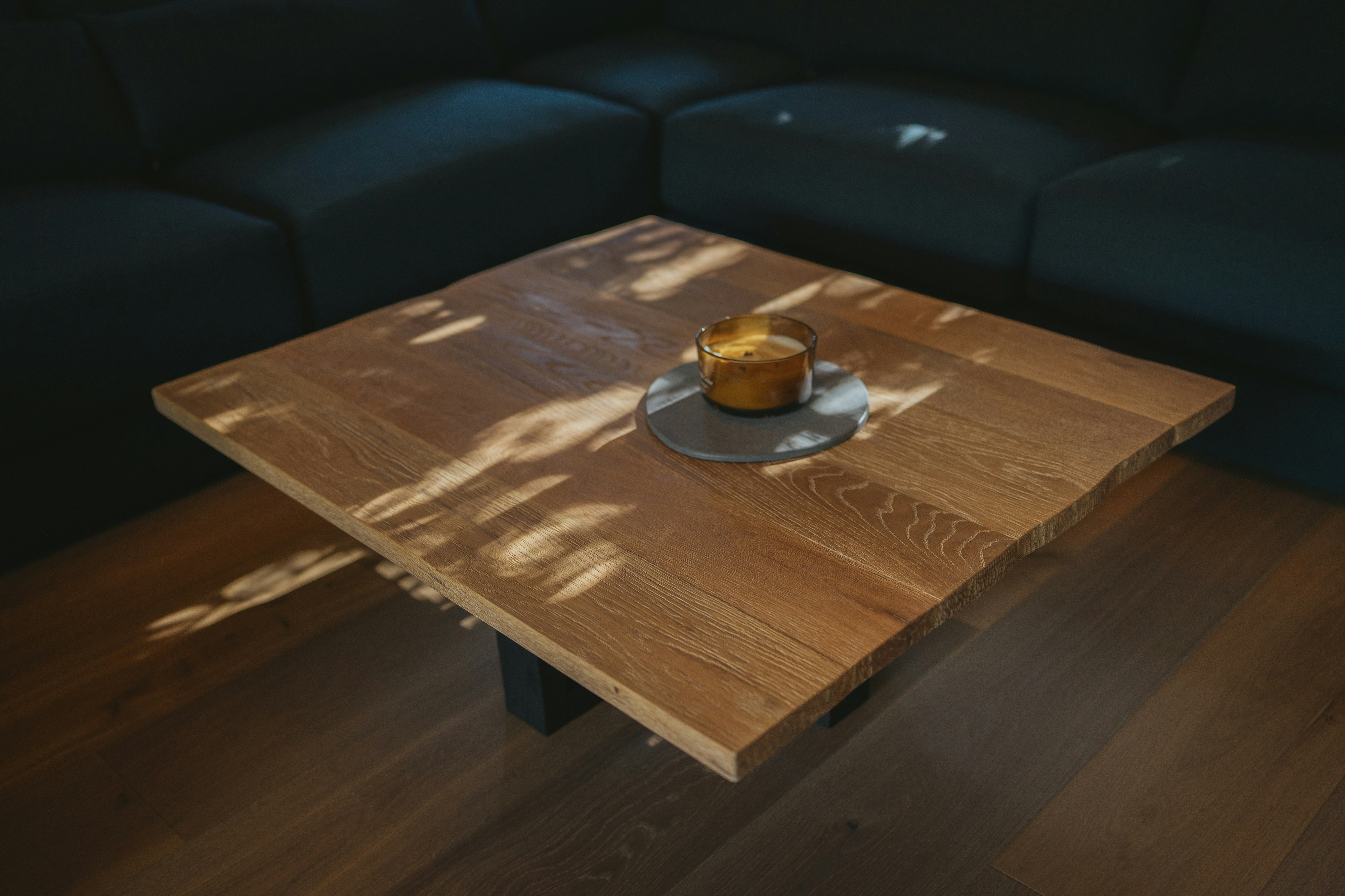 Amber Candle on a Minimalist Wooden Table