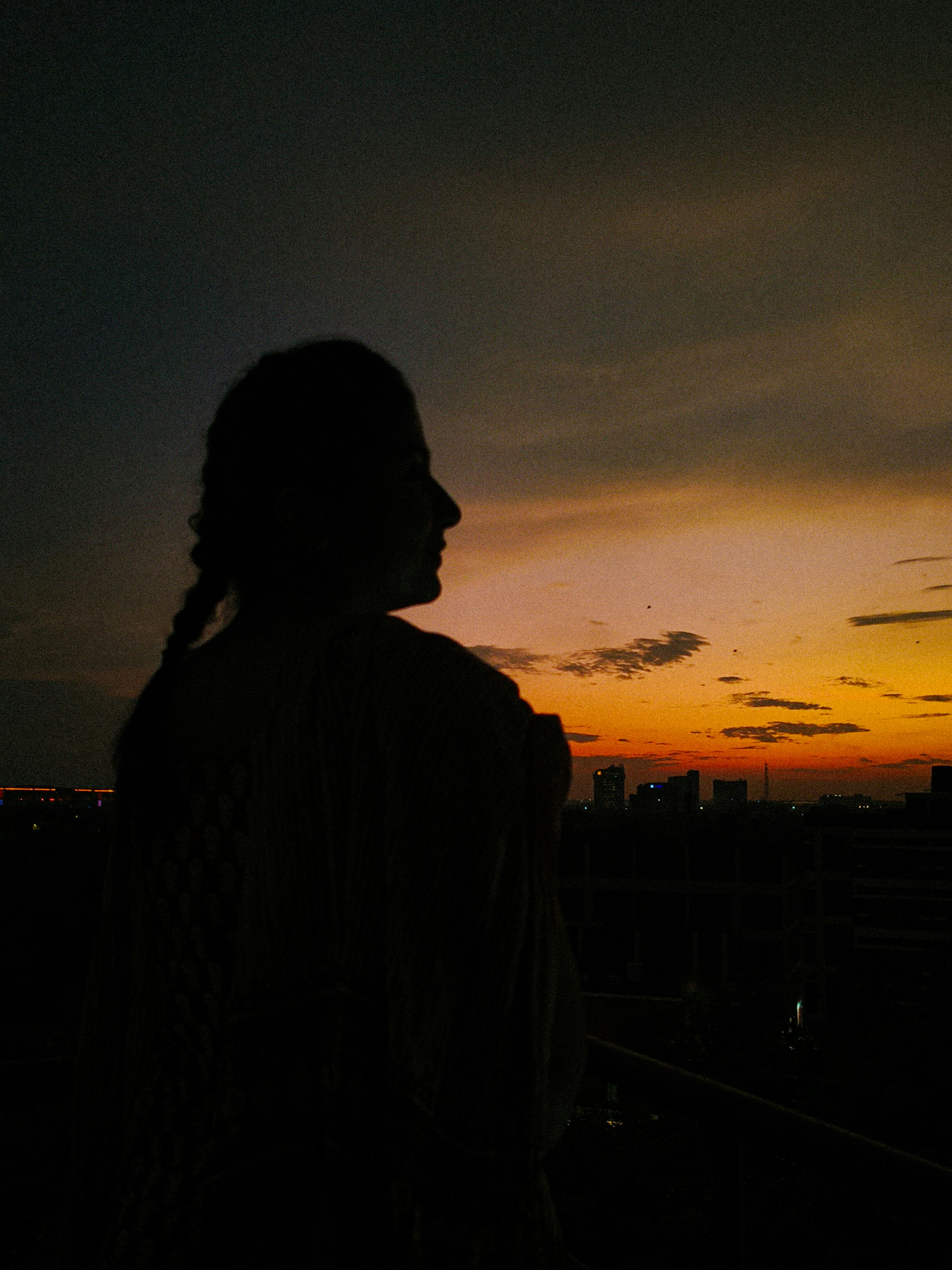 Silhouette at Dusk: A Quiet Balcony Moment