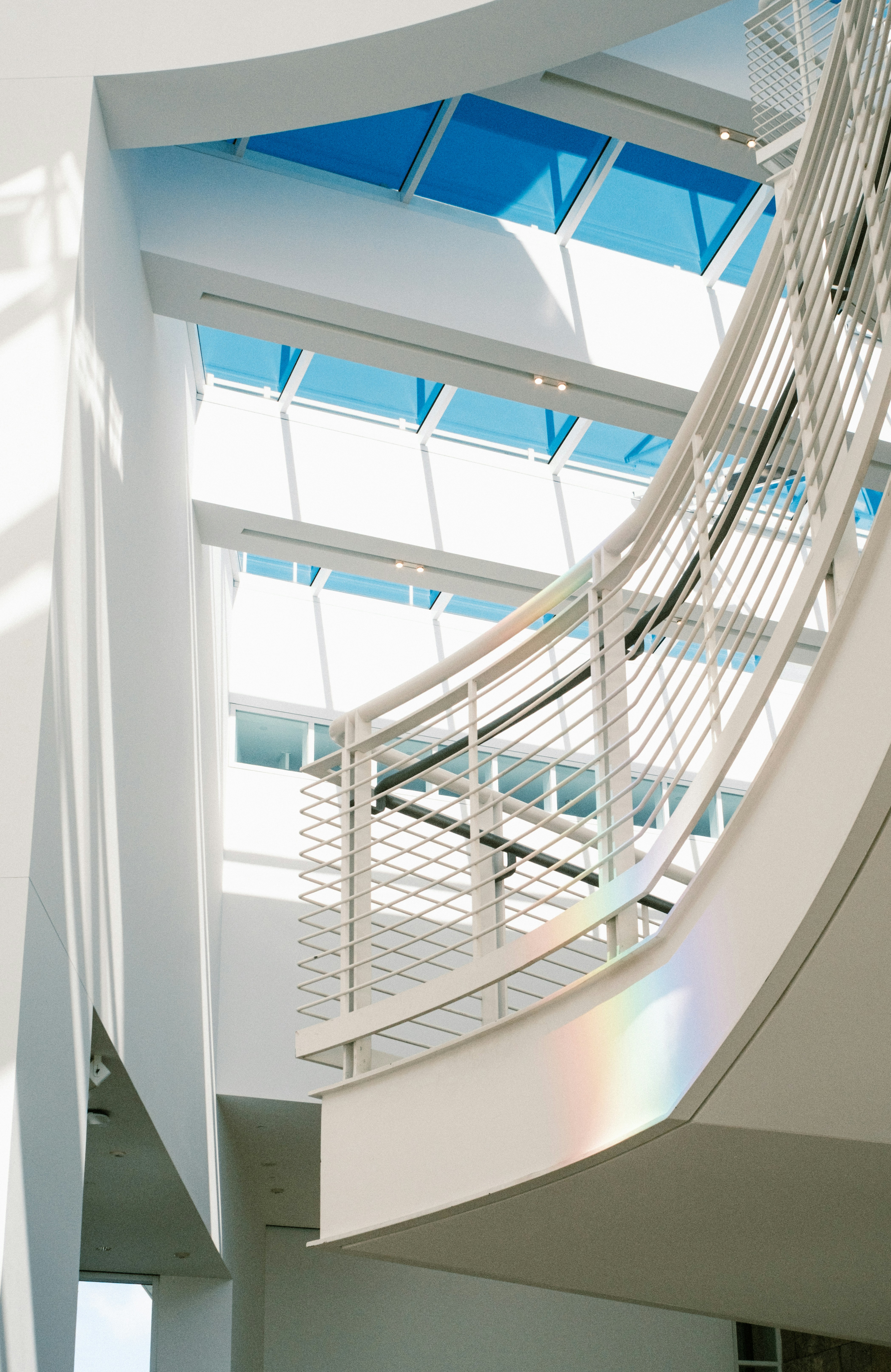 Ray of Sky Through Geometric Glass: A Modern Atrium Ballet