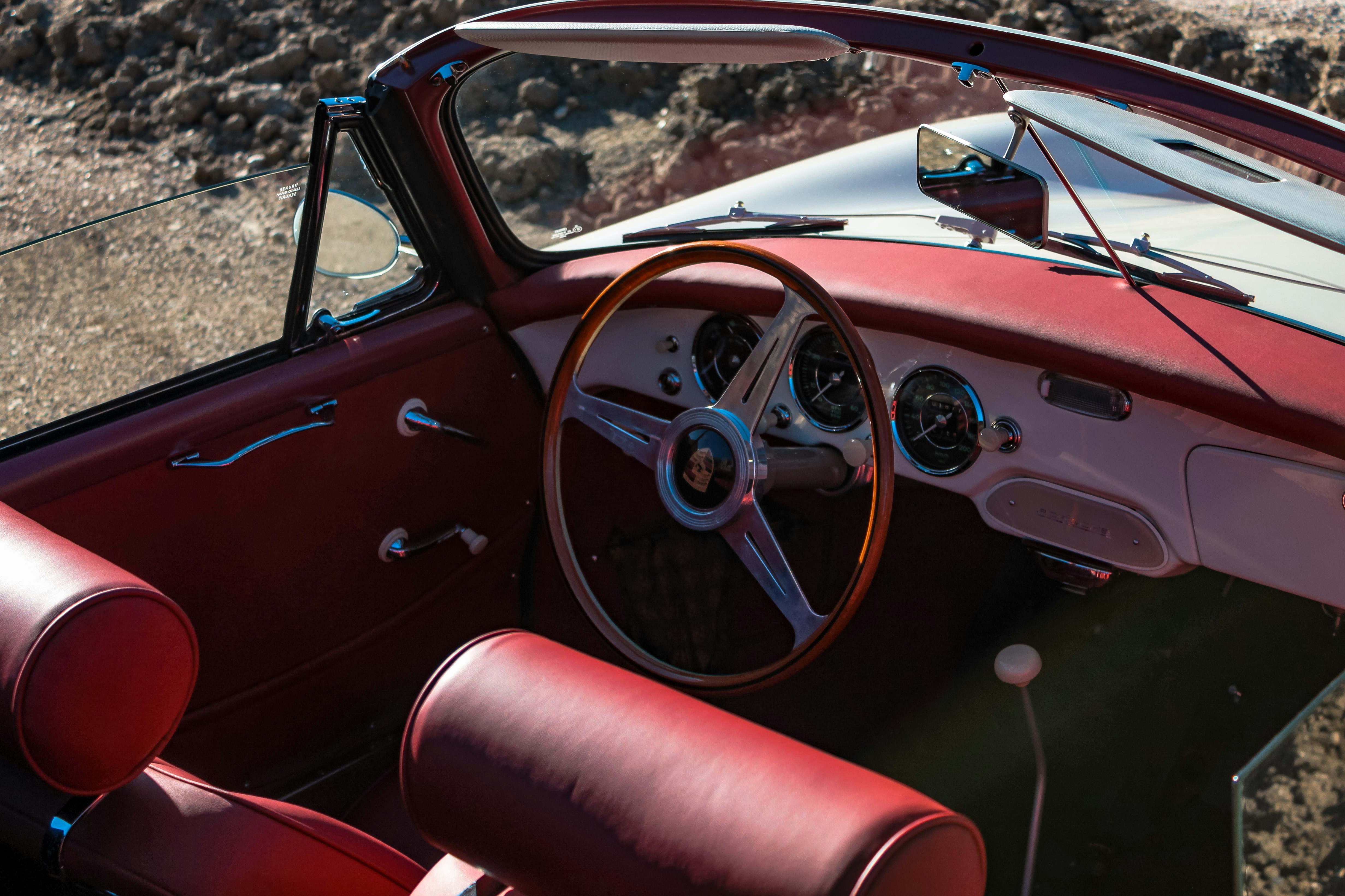 Crimson Cockpit: Vintage Convertible Interior Bathed in Sunlight