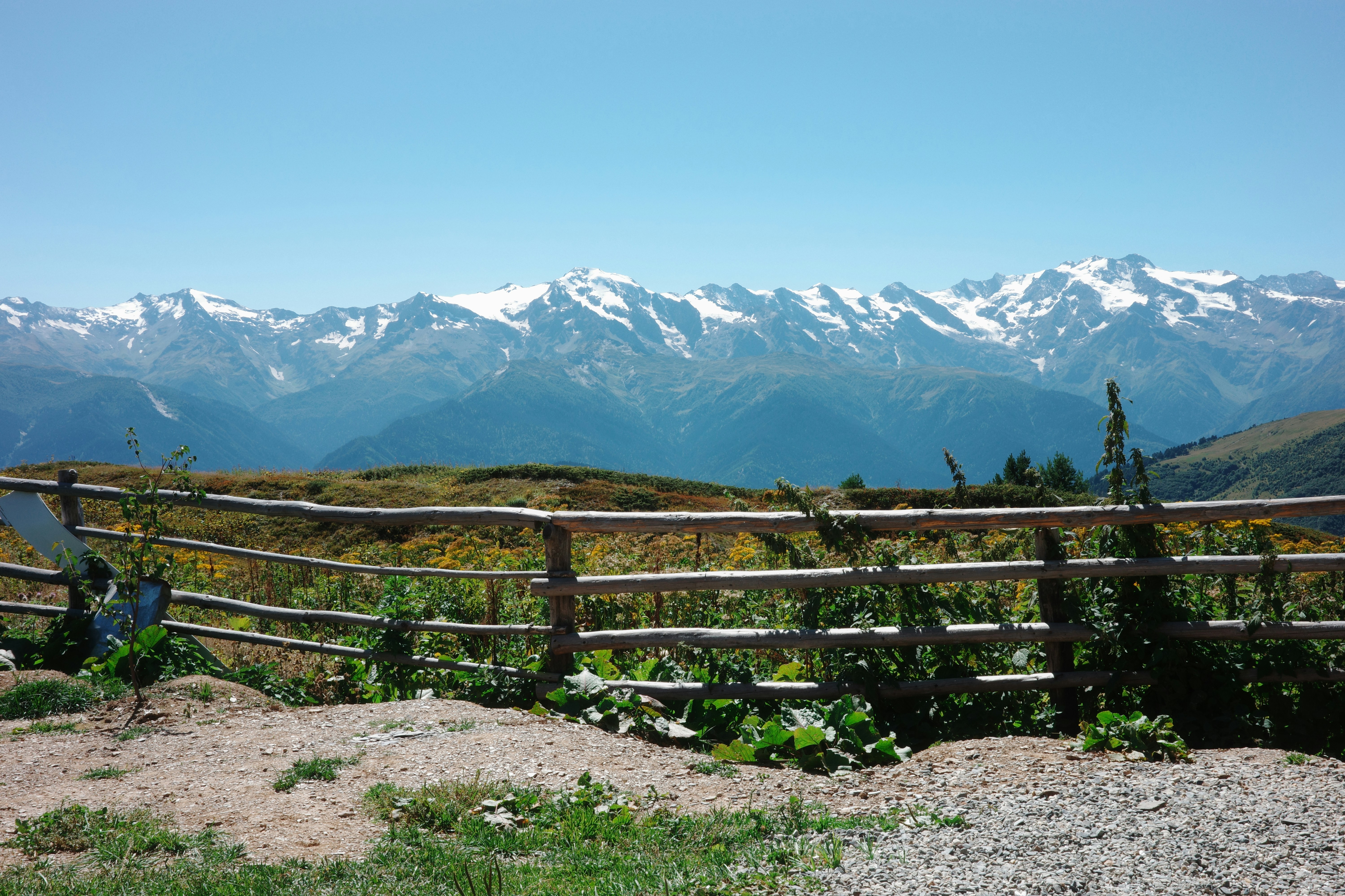 Snow-Capped Ridge Beyond a Weathered Fence