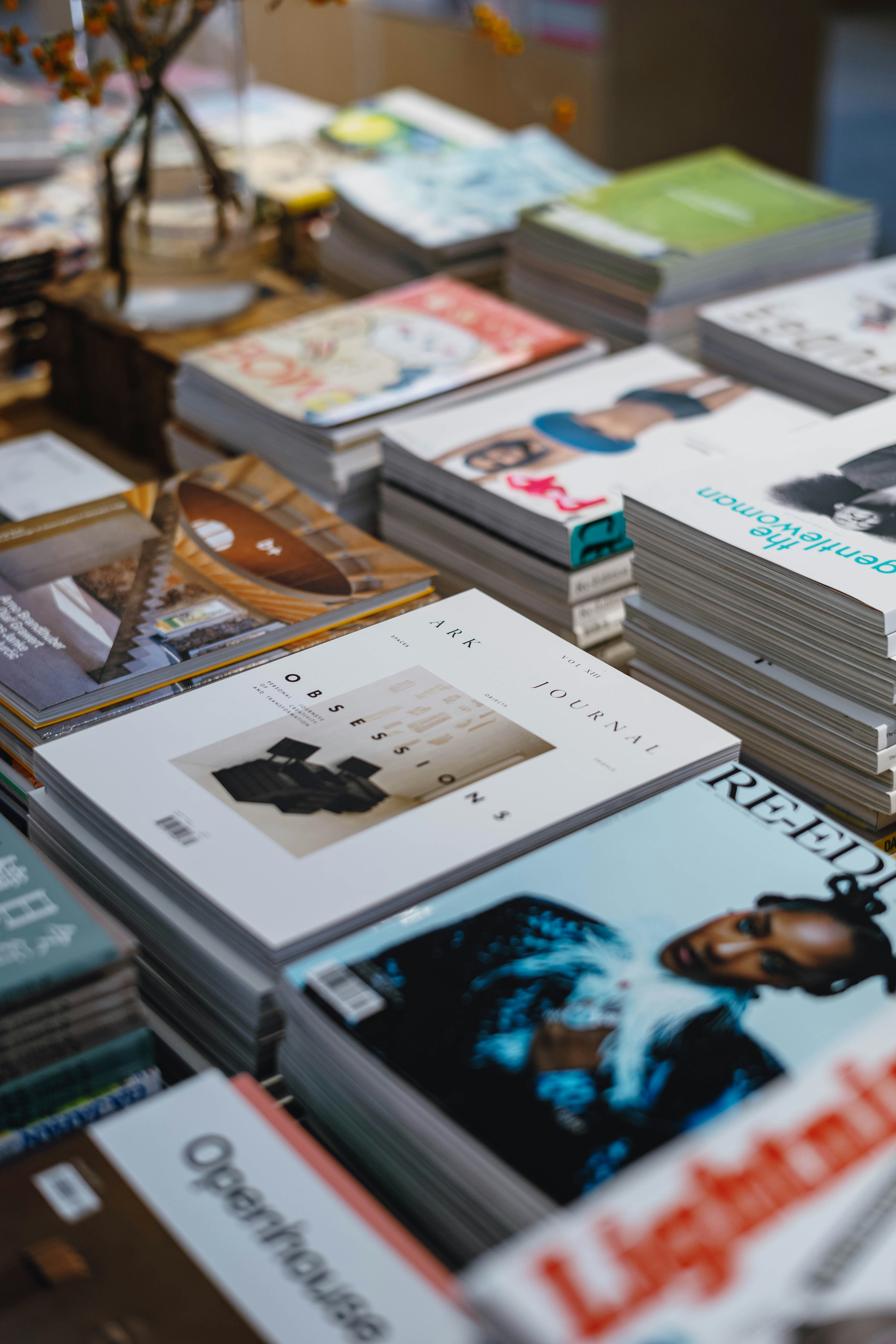 Colorful magazines neatly stacked in a bookstore display, inviting a closer look at glossy covers and varied typography.
