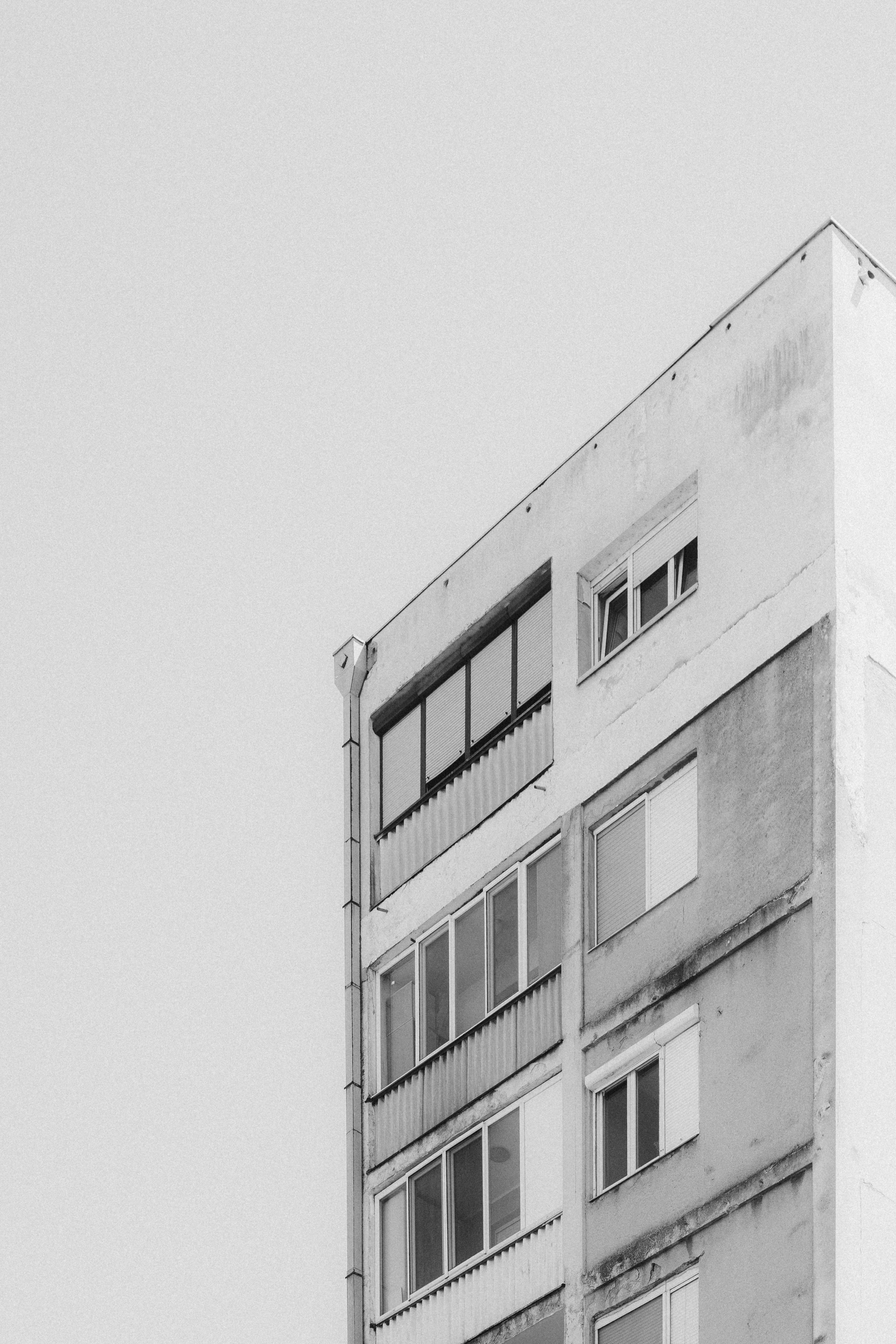 Urban Monolith: A Weathered Apartment Facade in Monochrome