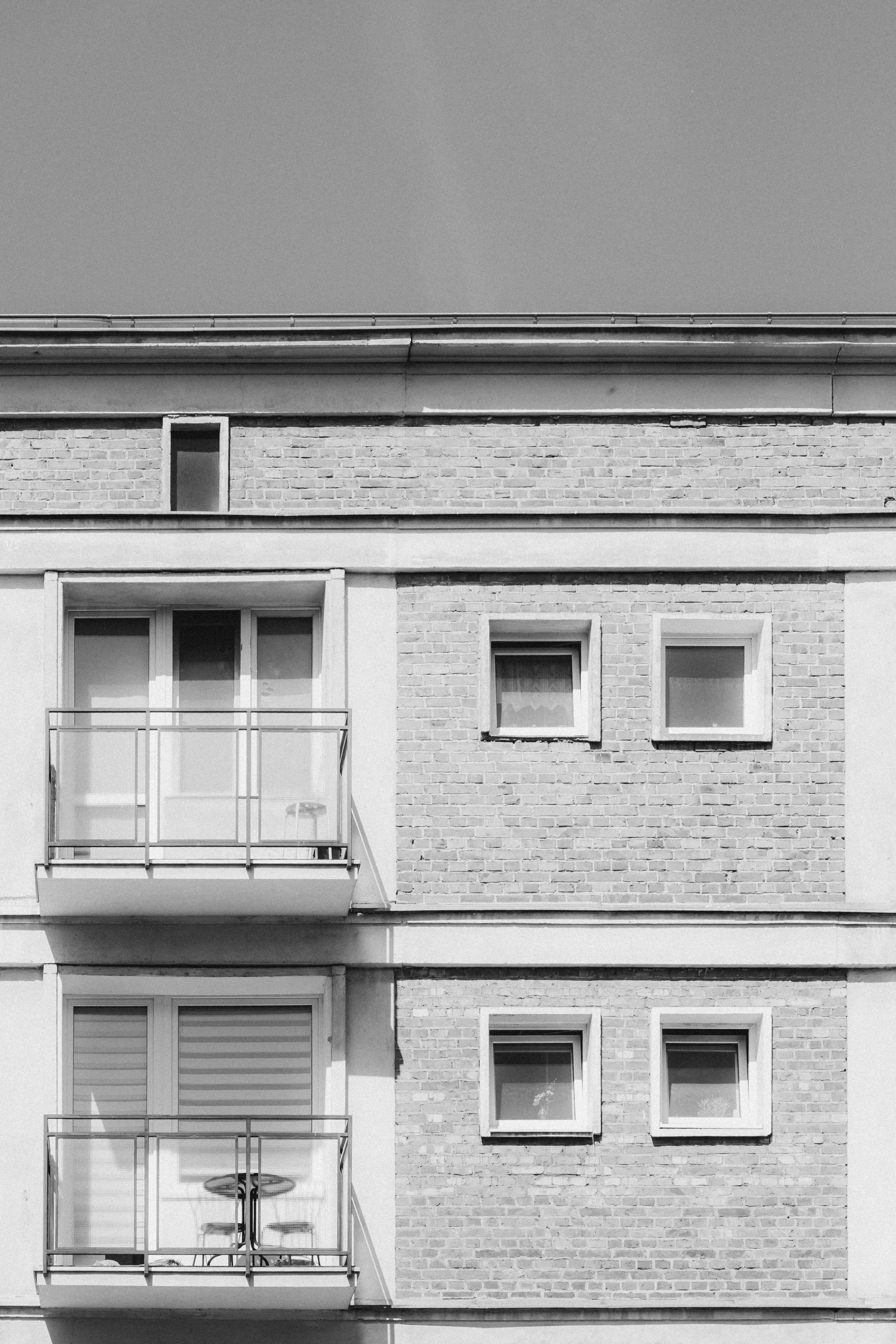 Brick Facade in Monochrome: Quiet Geometry and Balconied Silence