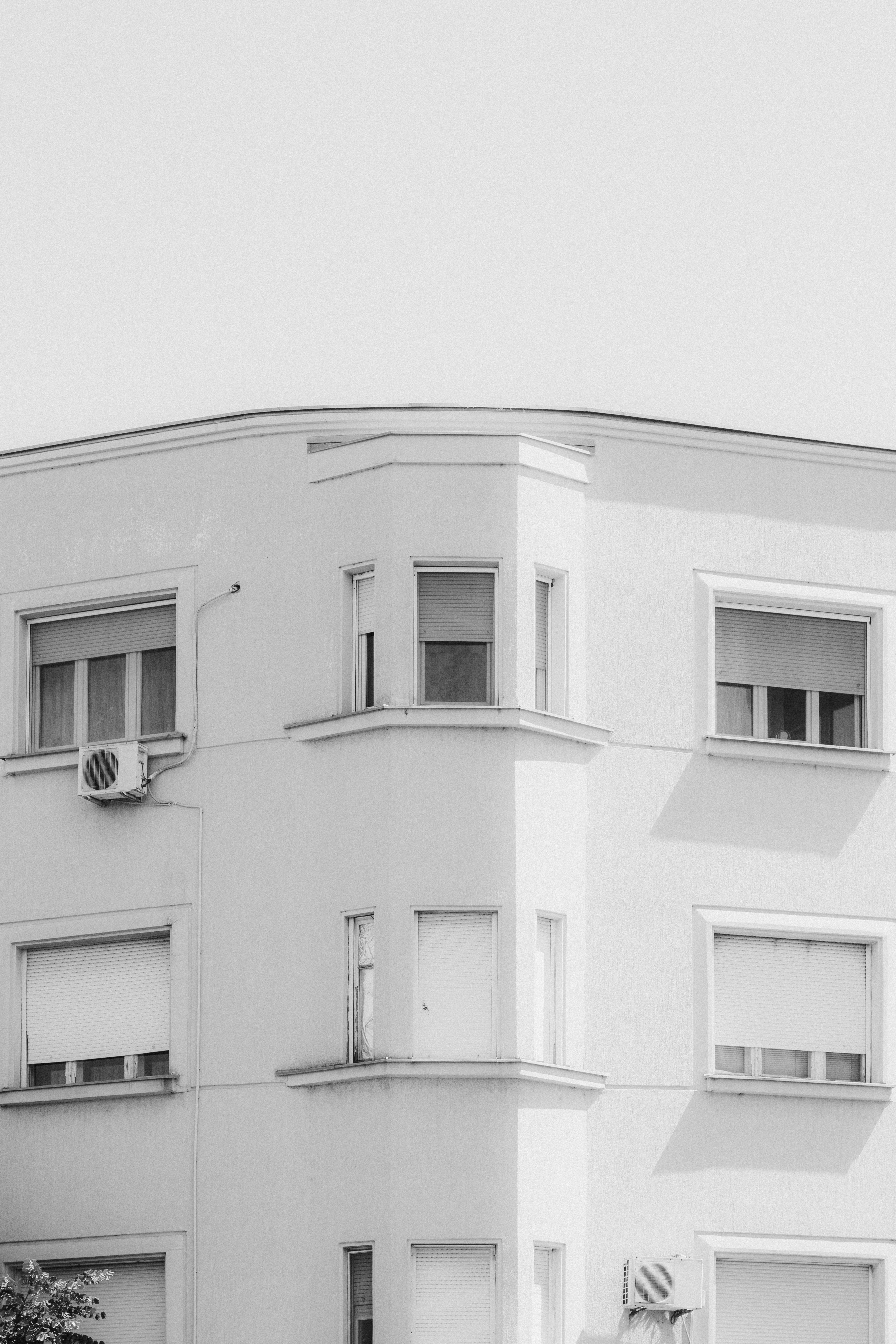 Monochrome Cornerstone: A Quiet Urban Facade in Light and Shadow