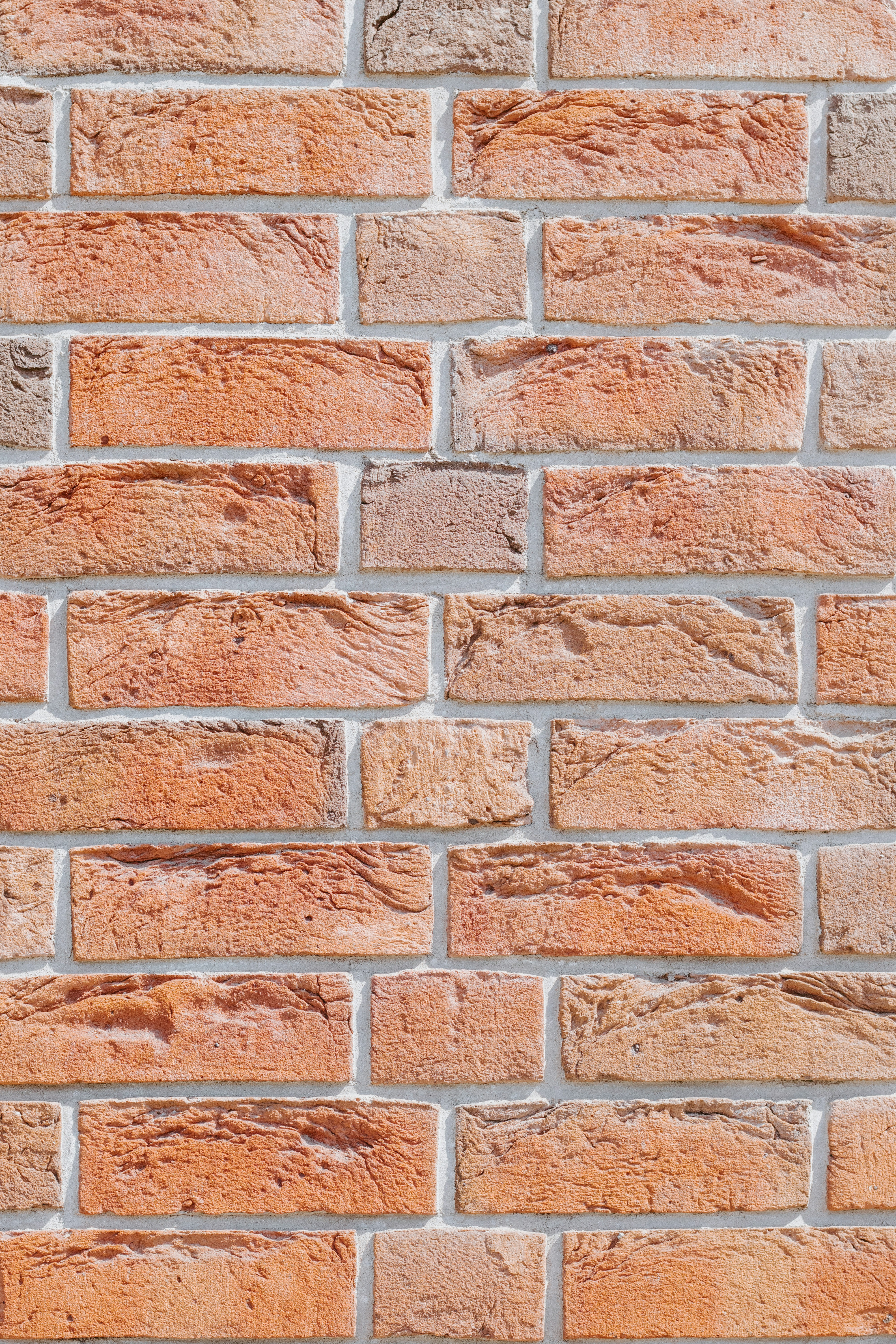 Brickwork in Even Rows: Subtle Texture of Sunlit Claret Tiles