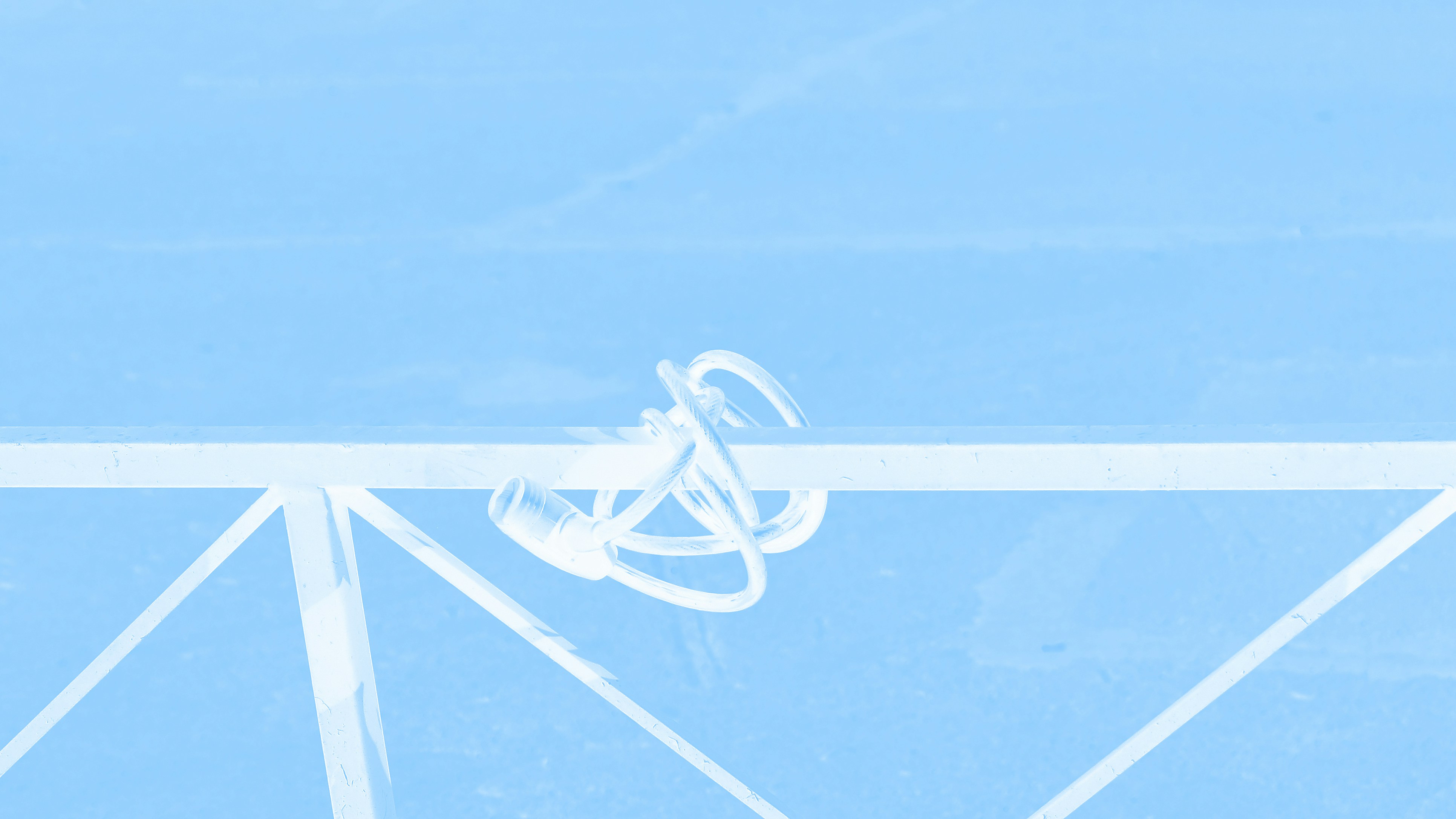 Blue Studio Ceiling with White Geometric Rail Markings and Tangled Cable