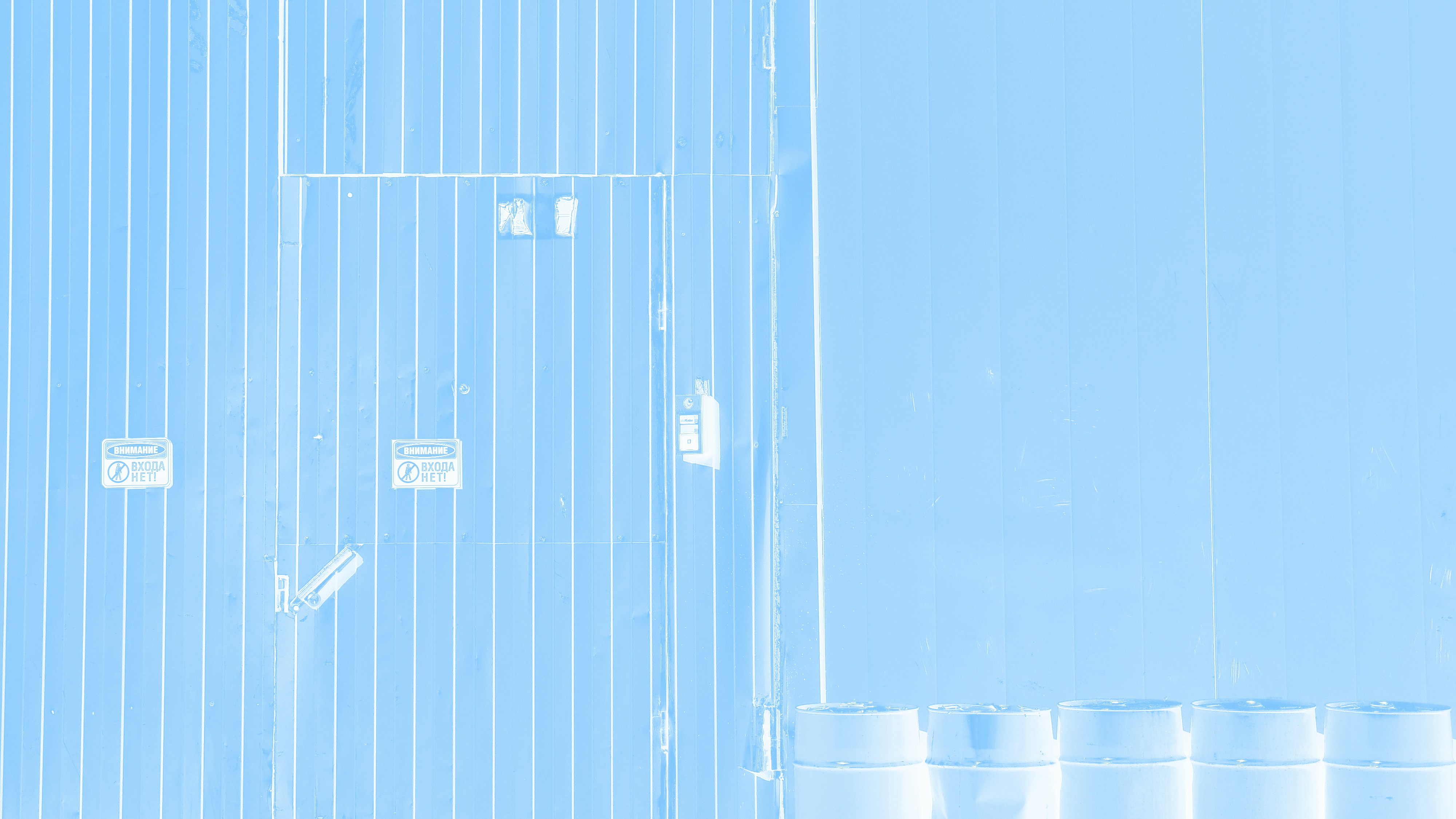 Industrial Quiet: Vertical Panels and Barrels in Soft Blue Light