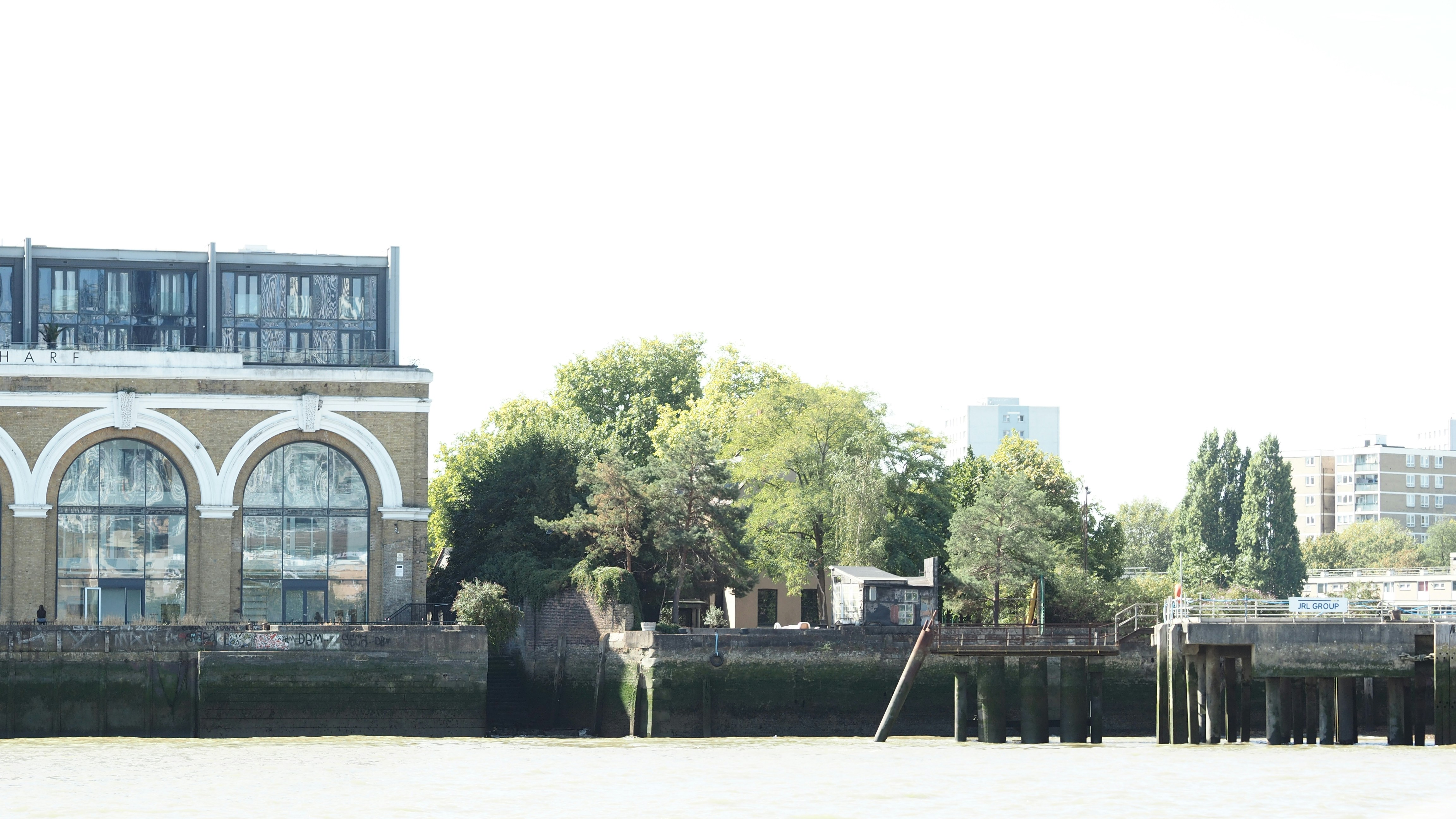 Harbor Edge: Arched Facade Meet Riverbank Dawn