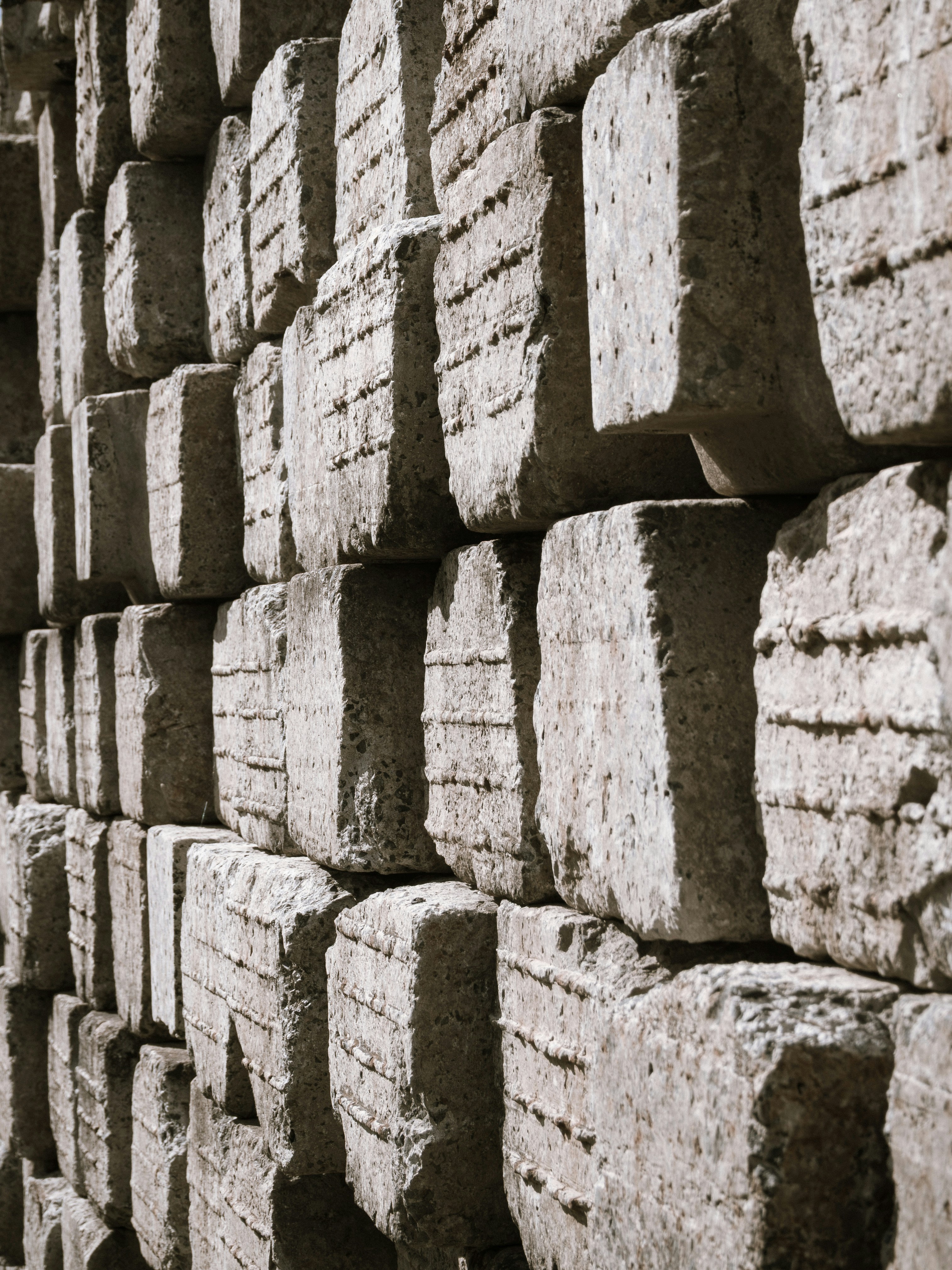 Rugged Grid: A Close-Up of Weathered Concrete Blocks