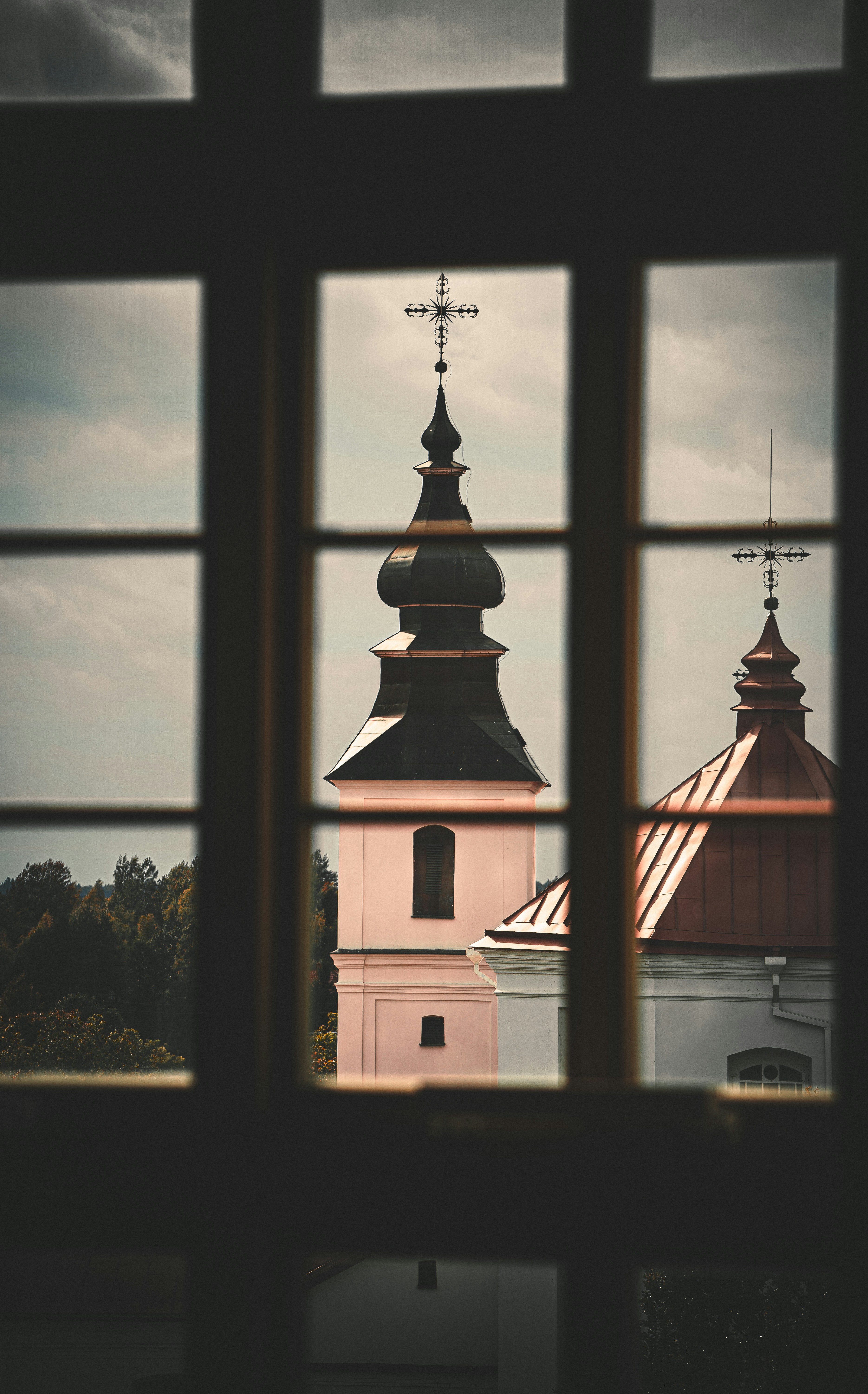 View Through the Grid: A Church Steeple in Soft Twilight