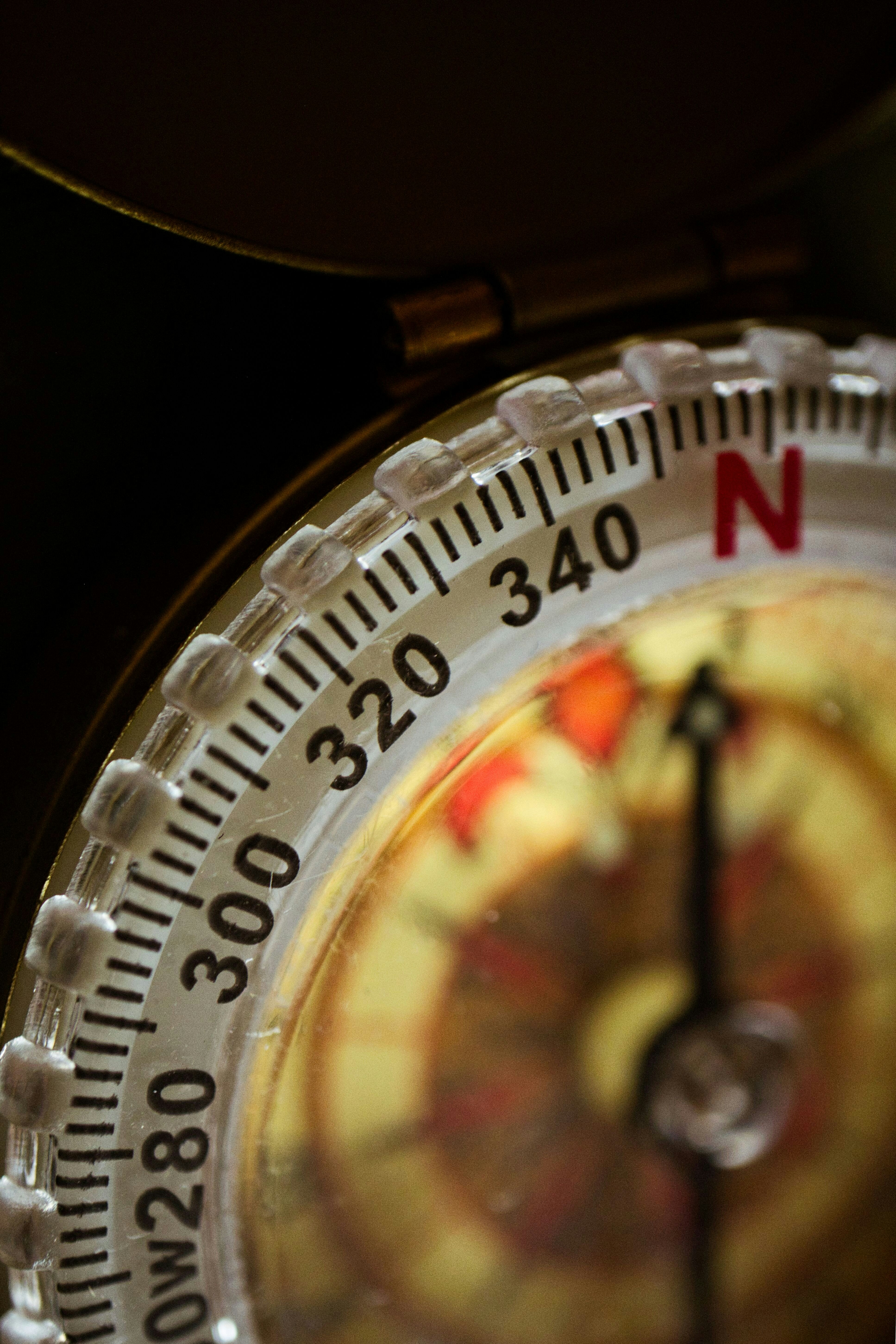 Magnetic Dial: A Close-Up of the Compass Face and Its Bold Red North N