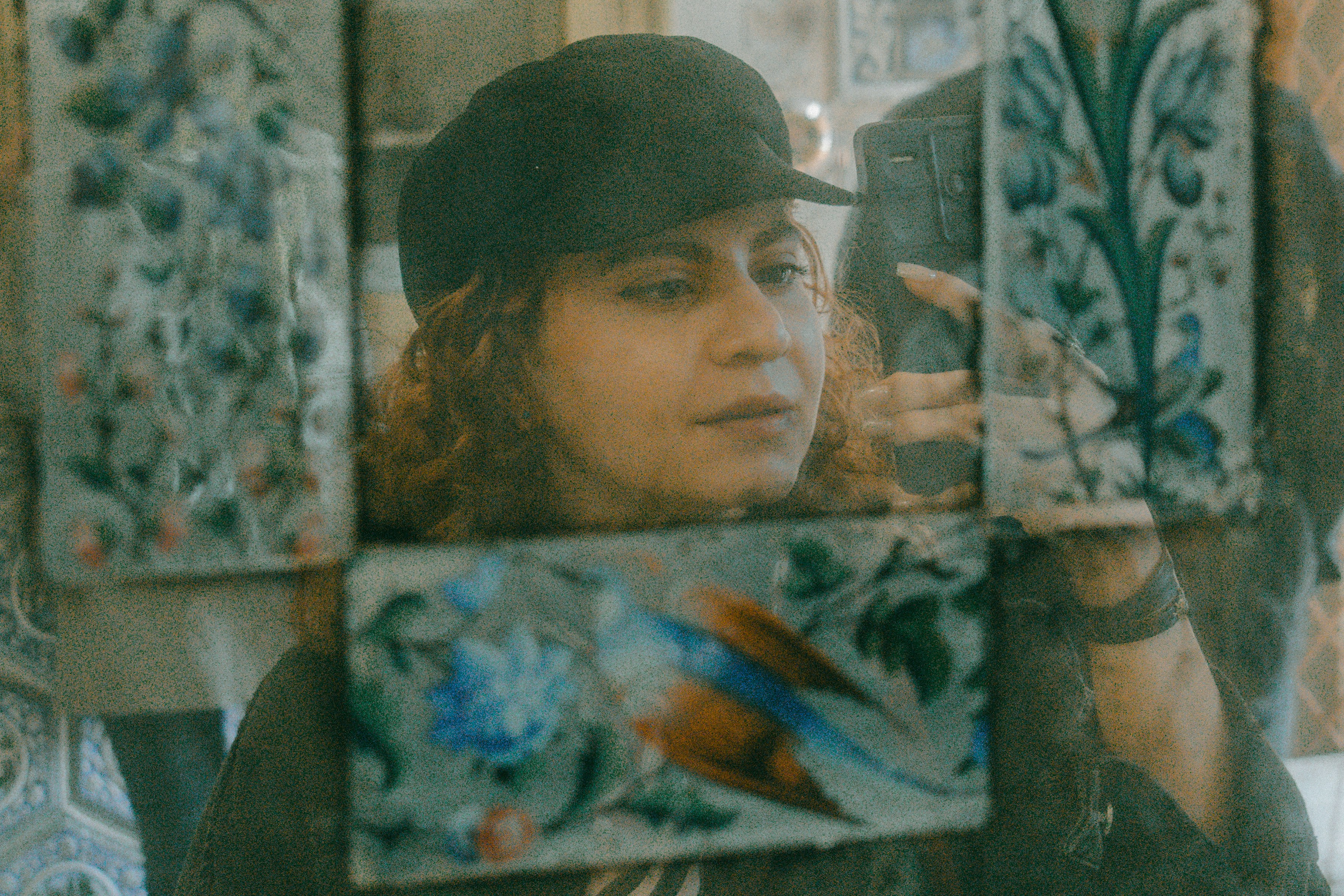 Mirrored Moment: A Quiet Self-Portrait in a Tile-Patterned Window