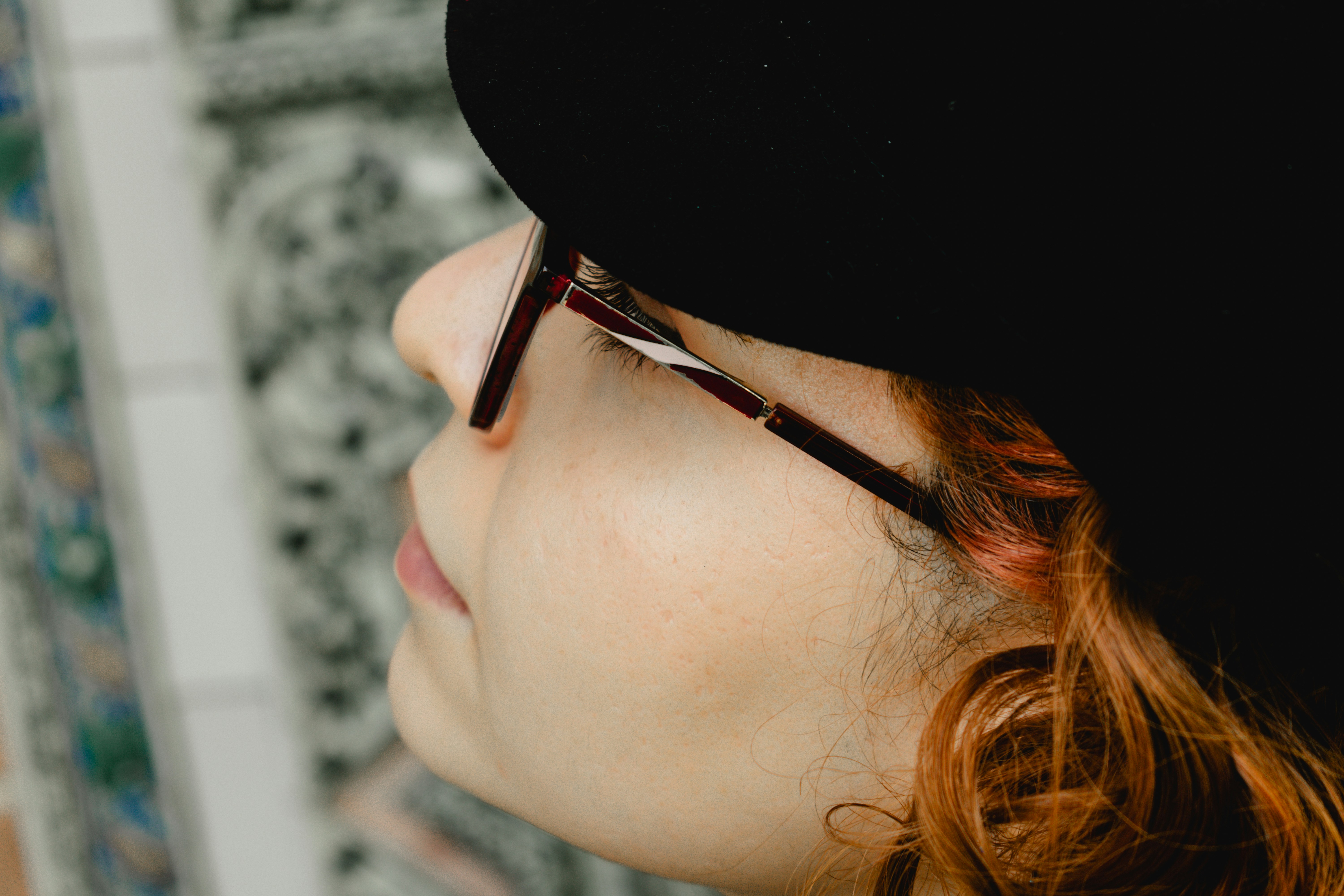 Side Profile in Soft Focus: A Quiet Moment with Glasses and Hat