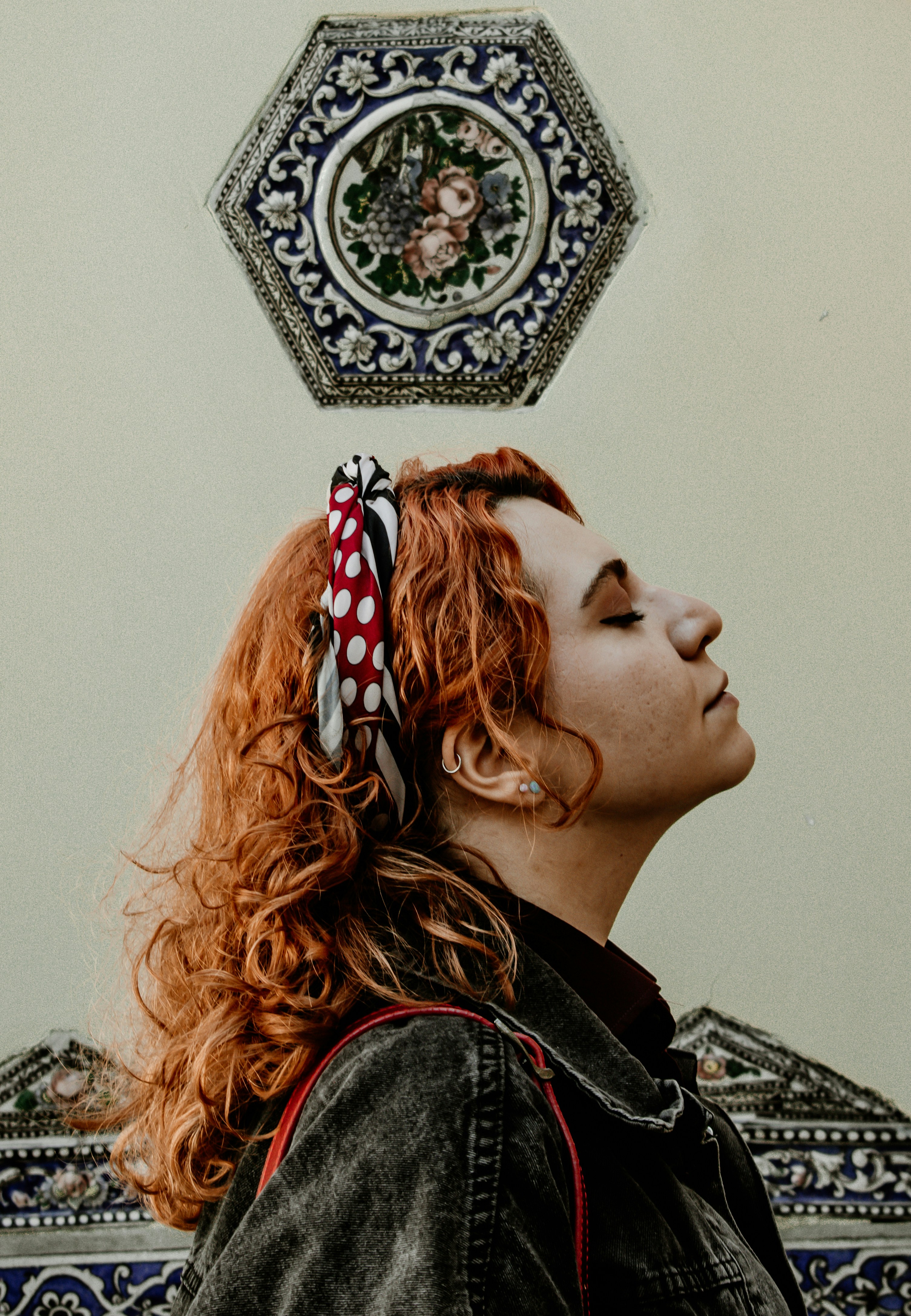 Red Curls and Quiet Reverie under a Hexagonal Tile