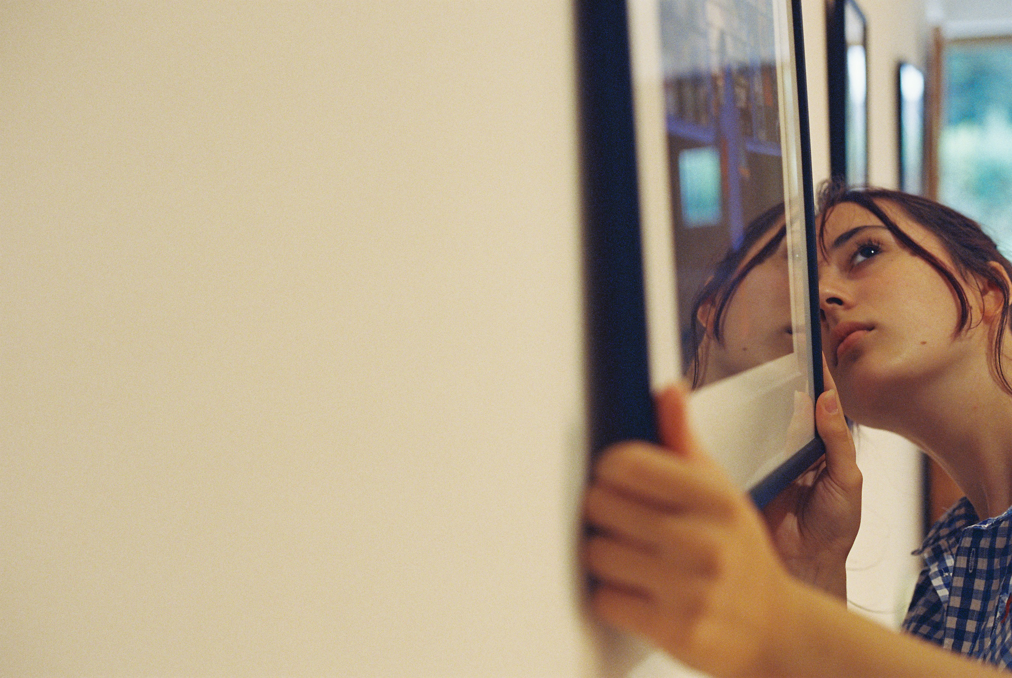 Mirrored Gaze: A Quiet Encounter with a Framed Moment
