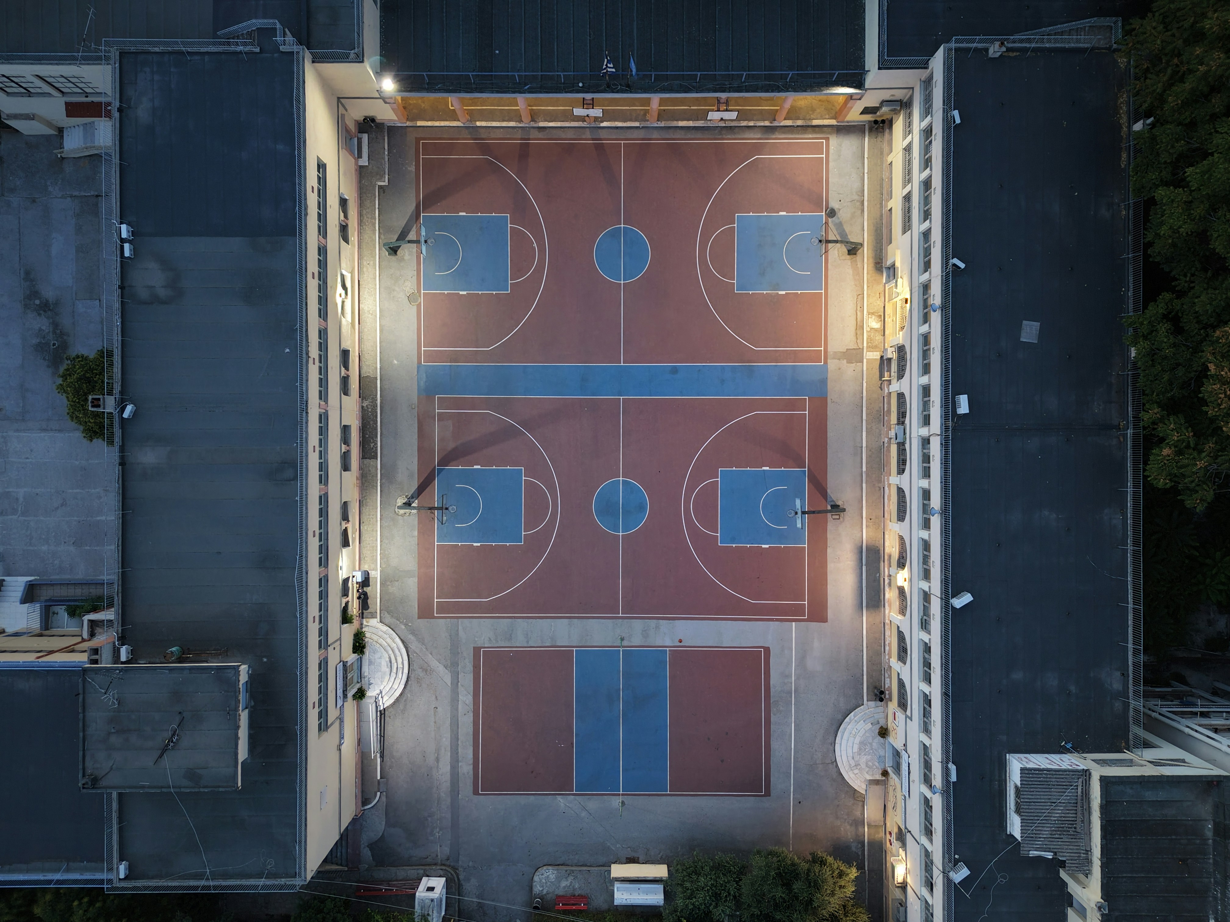 Aerial Chessboard: Twin Basketball Courts Within Civic Courtyard