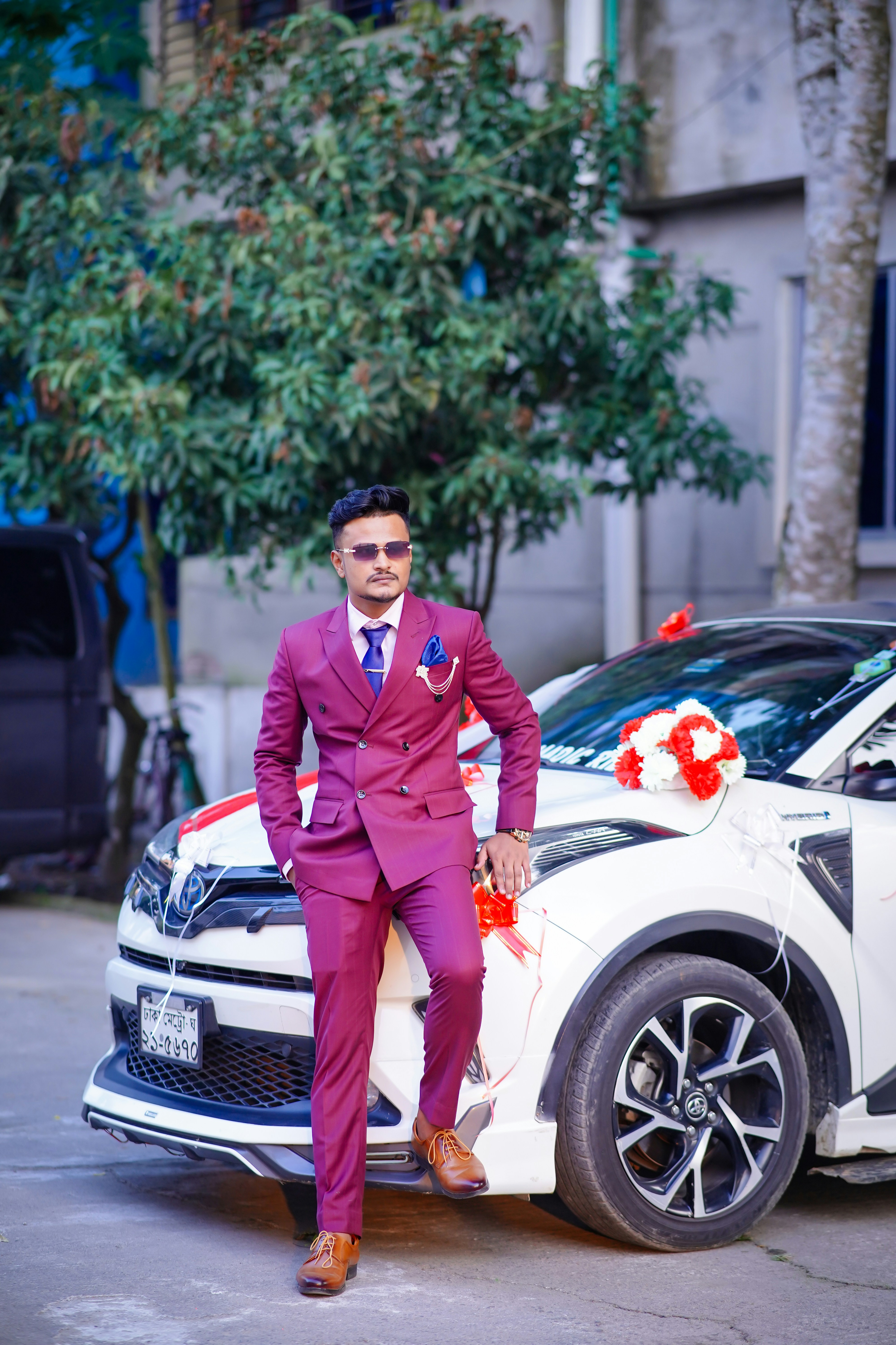 Crimson Suit, White Car: A Dapper Entrance to the Ceremony