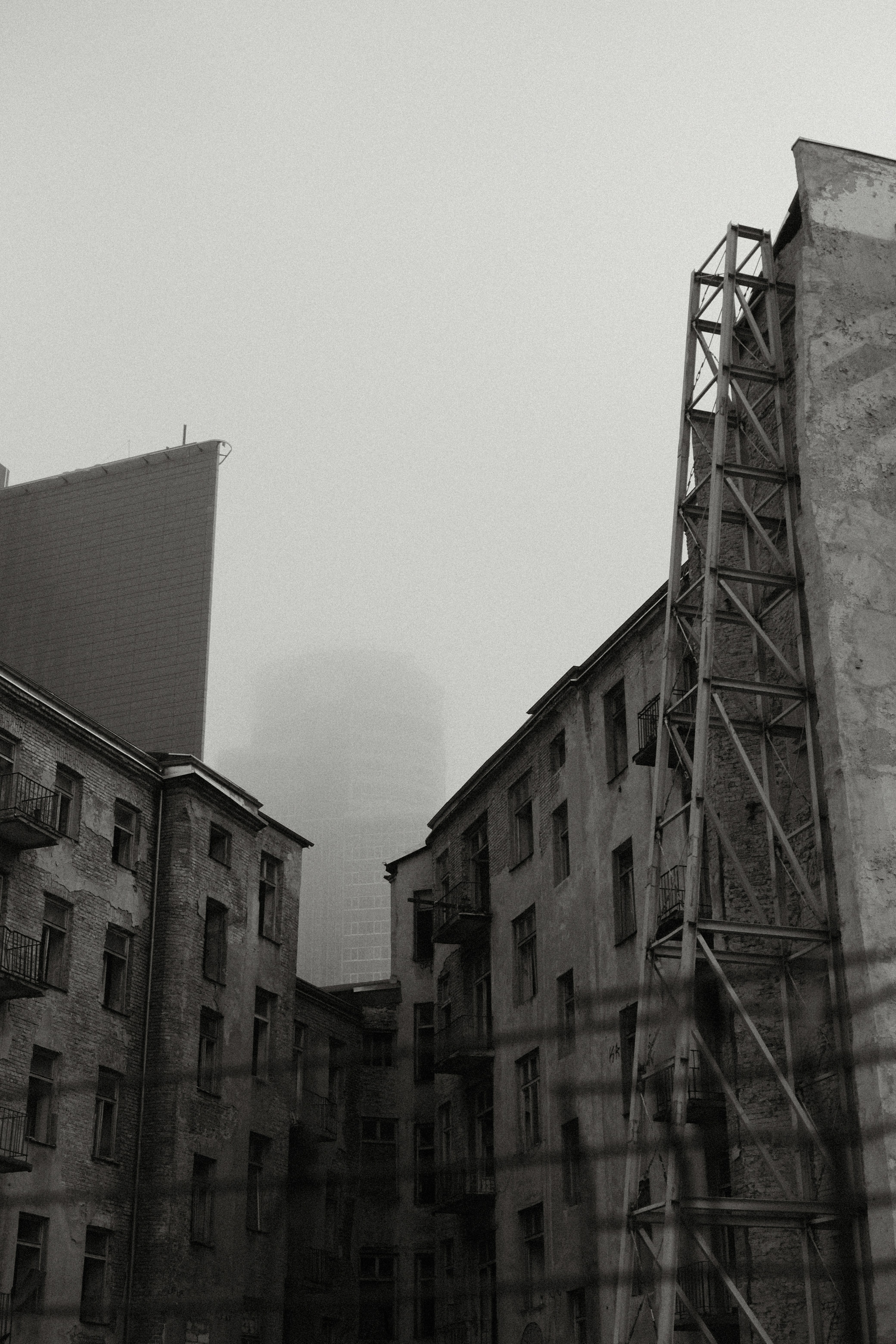 Urban Shadows: A Narrow Alley Climb into Fog and Architecture