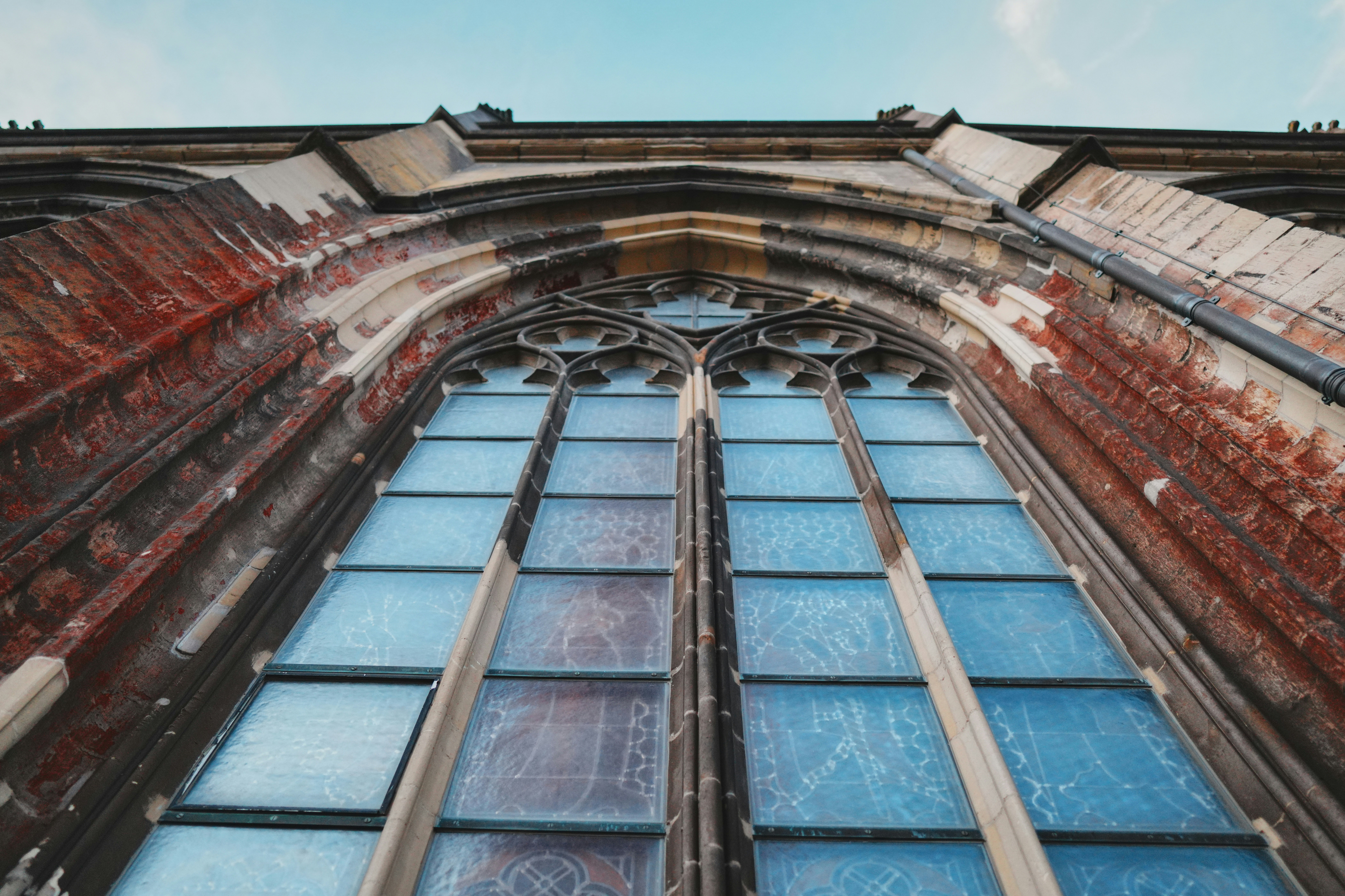 Gothic Window Arch Rising from Brick Facade