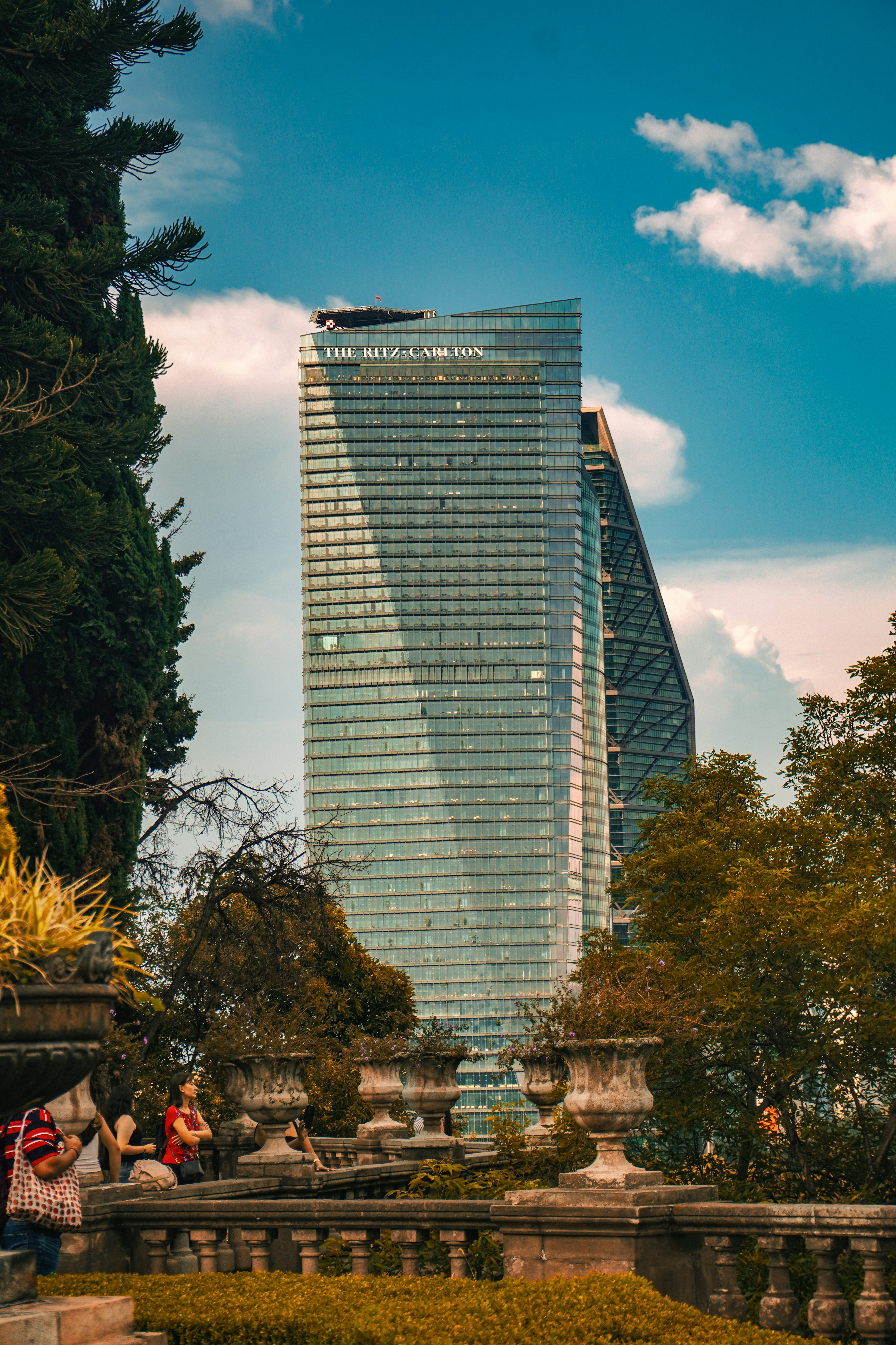 Skyline Embrace: The Ritz-Carlton Tower Rising Over a Classical Terrace