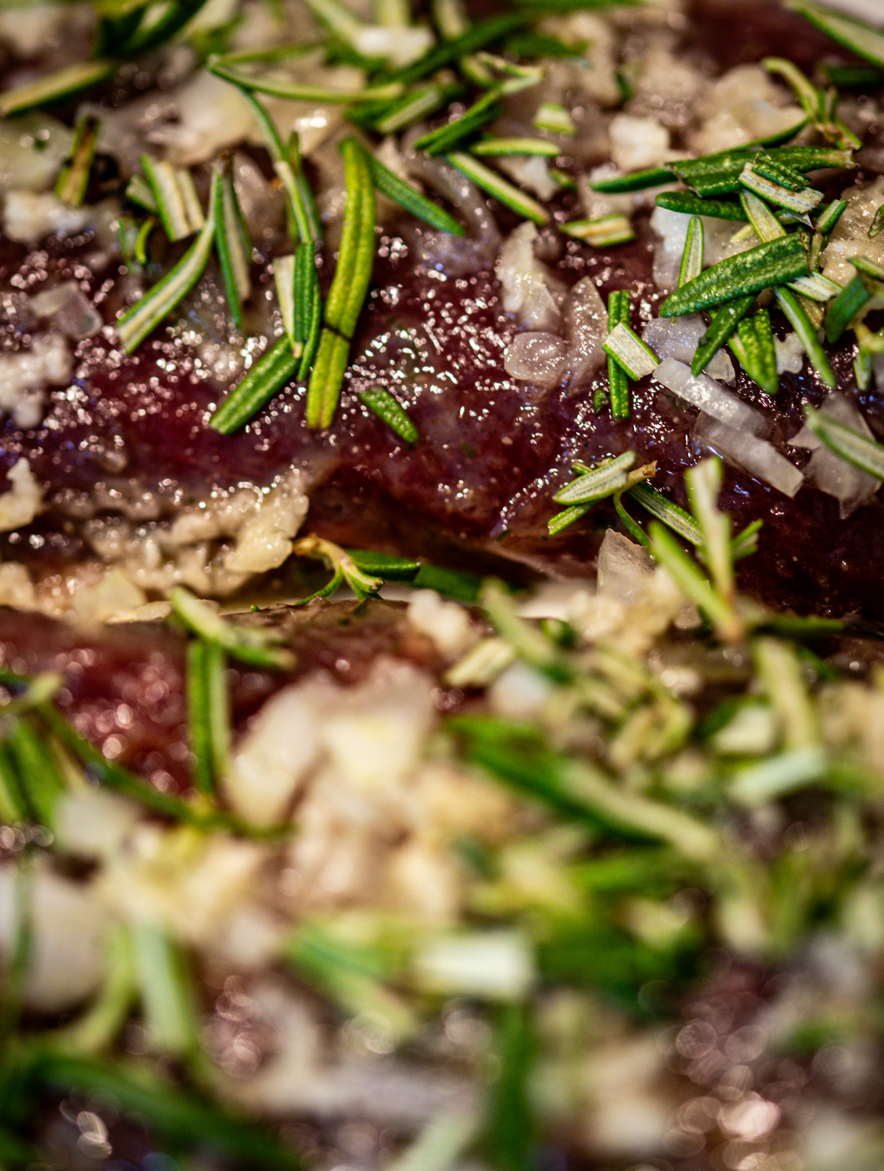 Herbed Crust on a Juicy Cut: Rosemary-Flecked Steak Close-Up