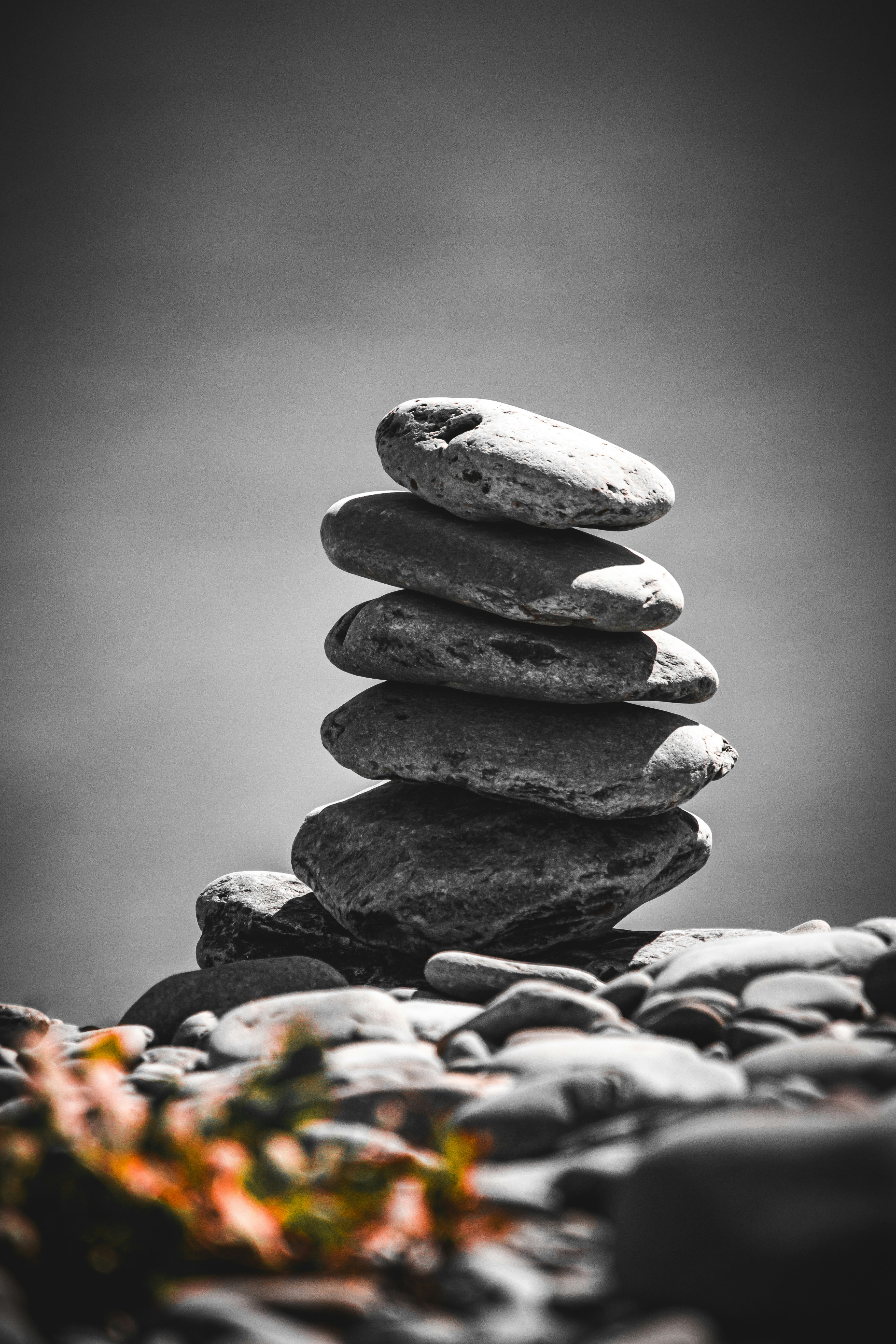 Pebble Quiet: A Balanced Stack Against a Blurred Shore