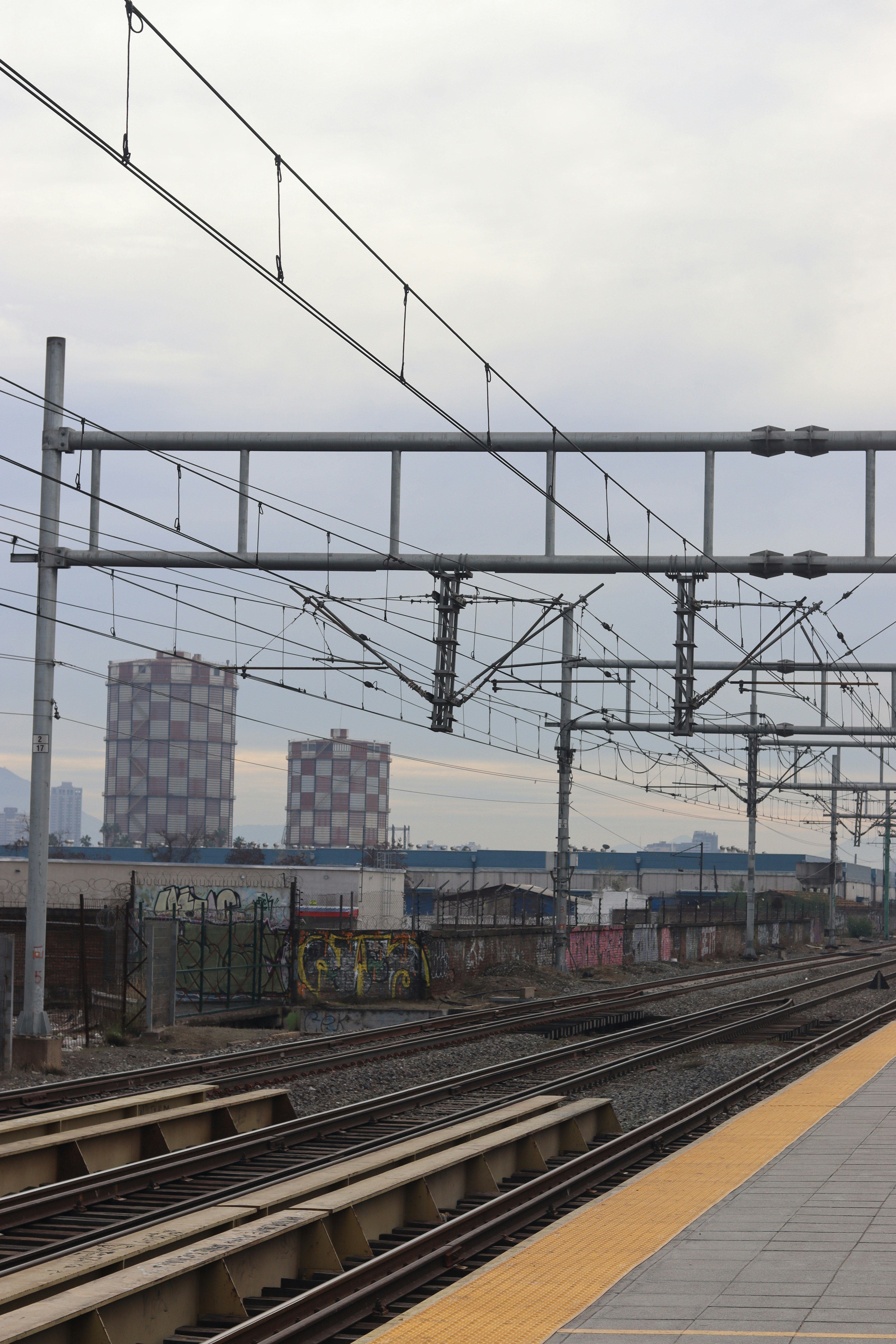 Industrial Rails Under Overhead Lines at Dusk