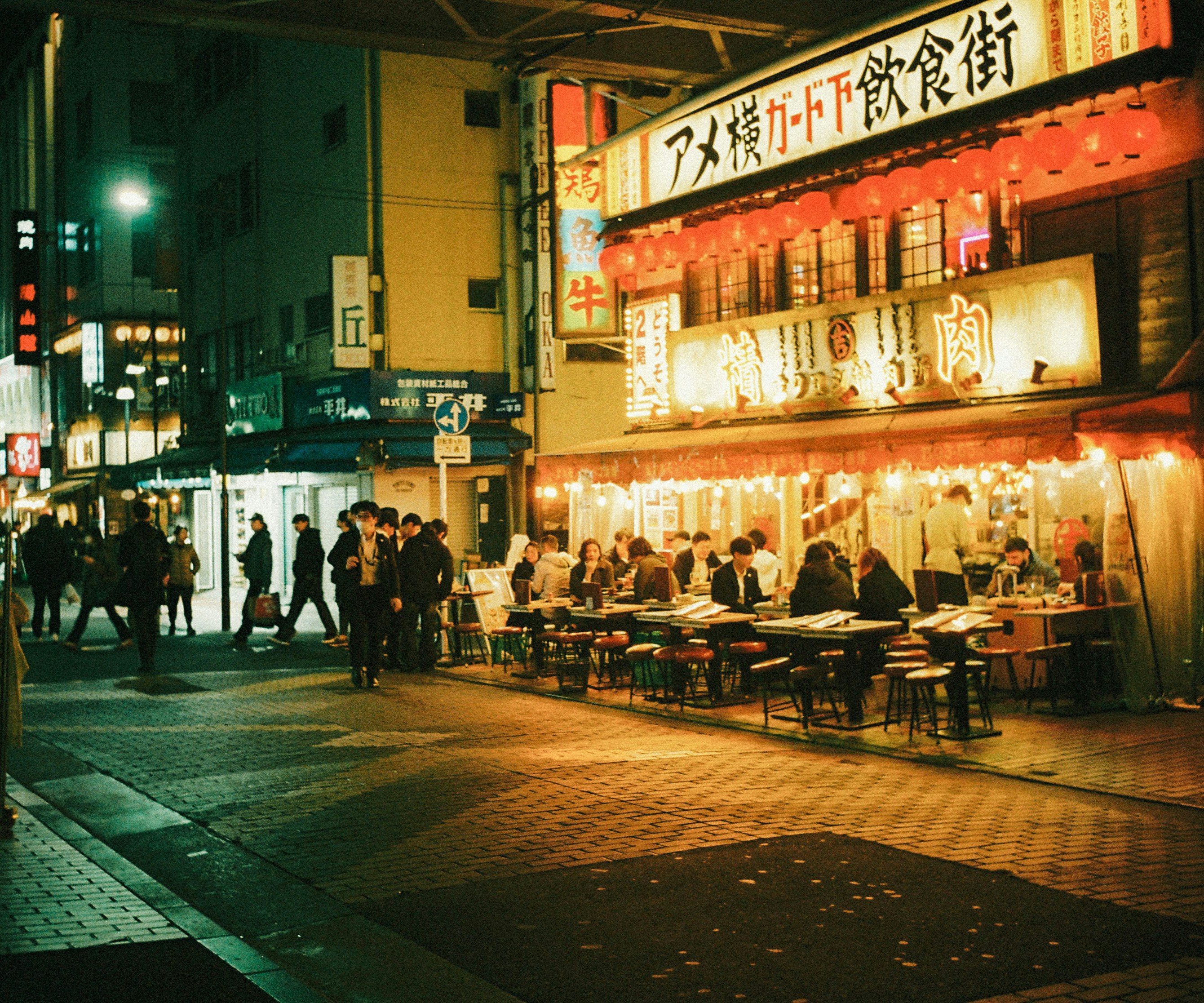 Night Market Chorus: Warm Lights Spill Over a Bustling Eatery Block