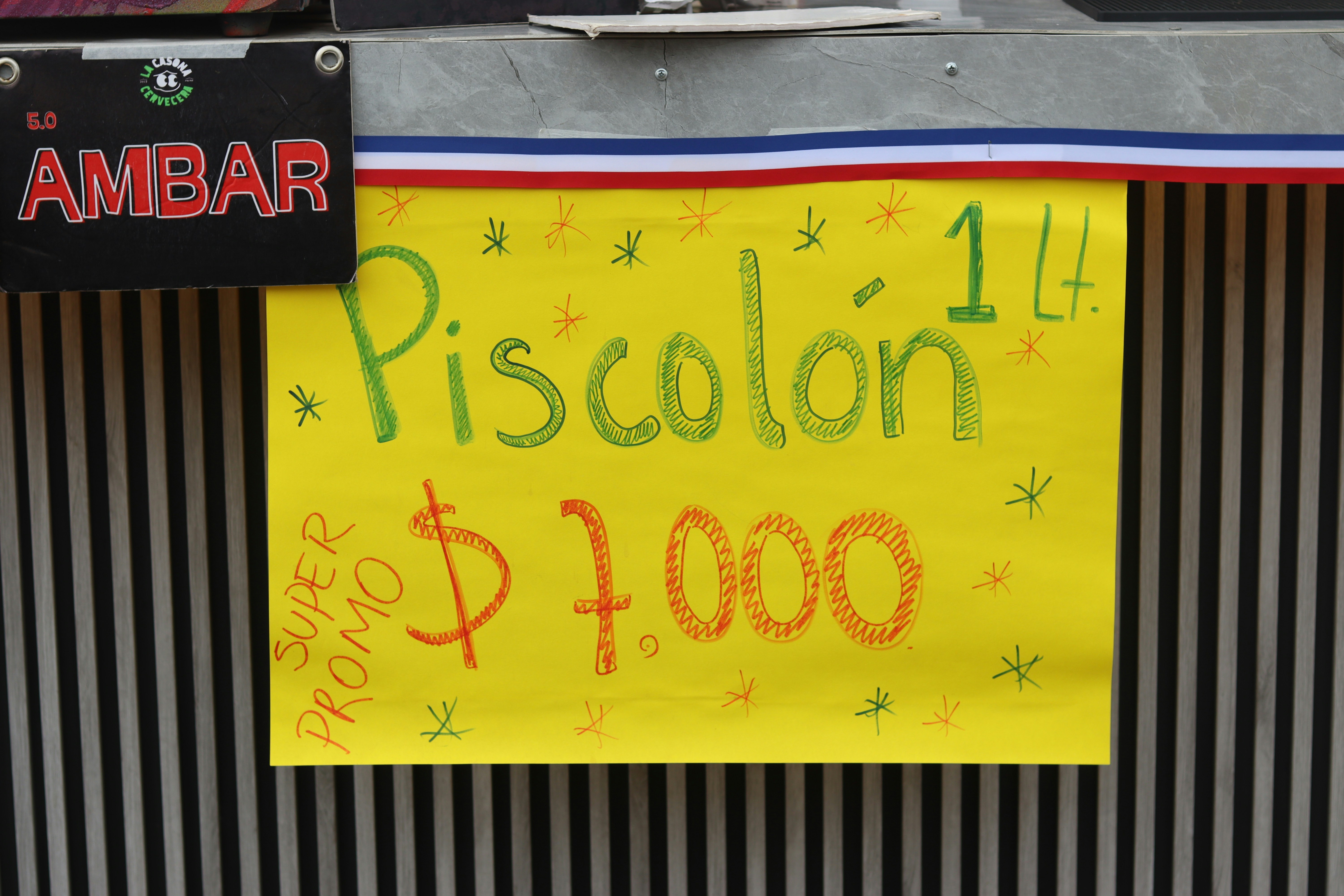 Bright Yellow Promotion Sign for Piscolón with Handwritten Typography