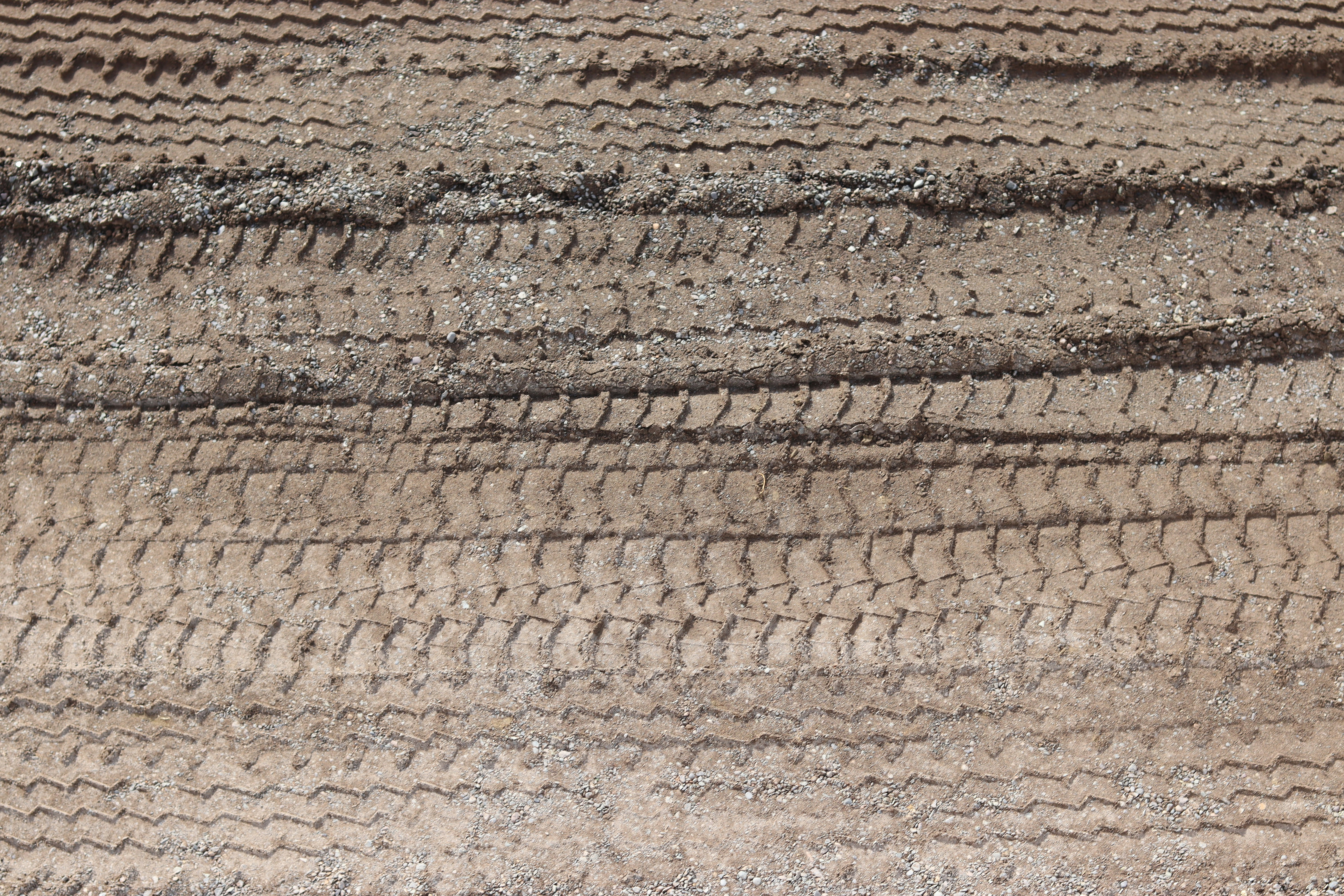 Tire Tread Textures in Sand — a close-up study of patterned tracks
