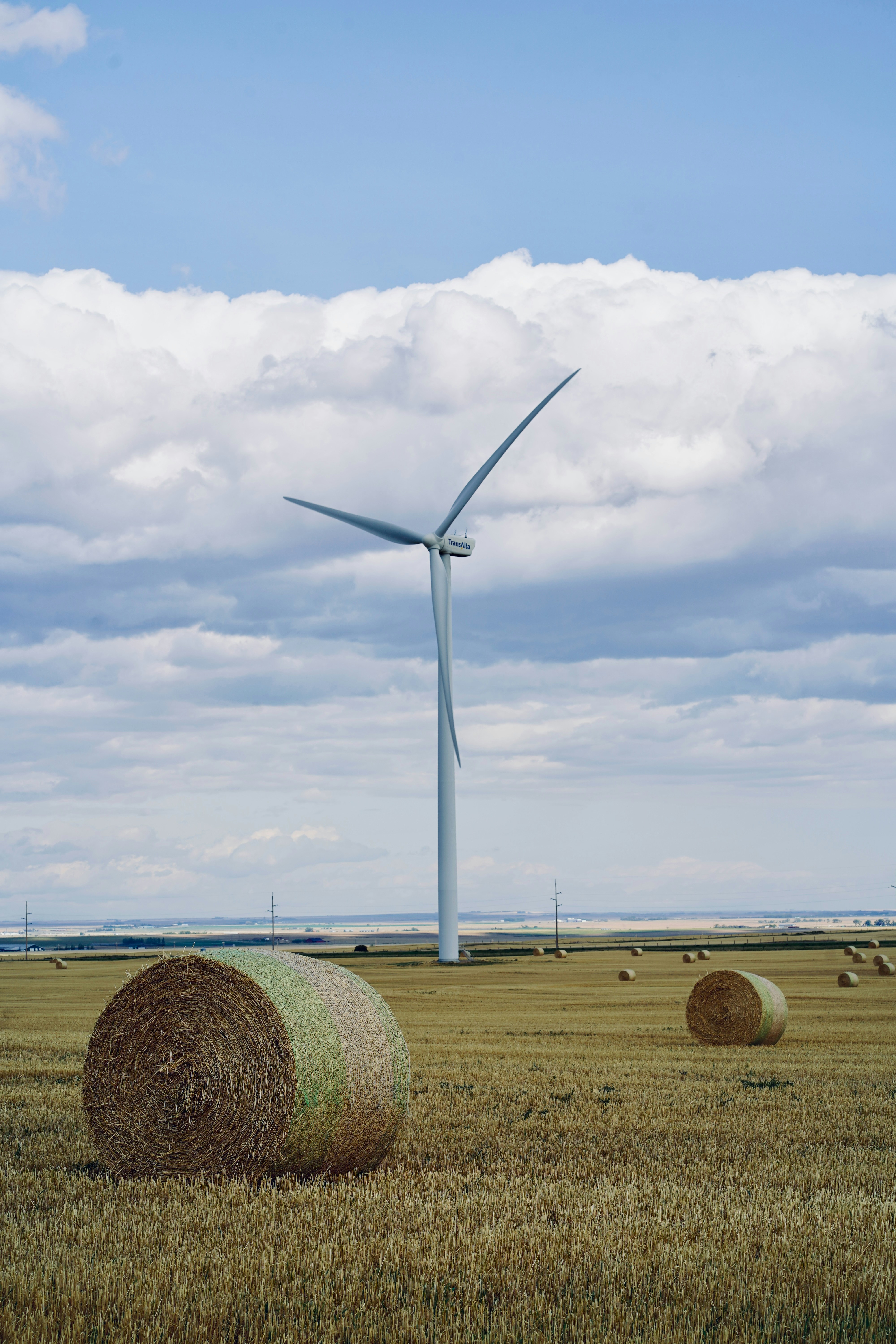 Wind Giant on the Flat: Hay Bales and a Lone Turbine