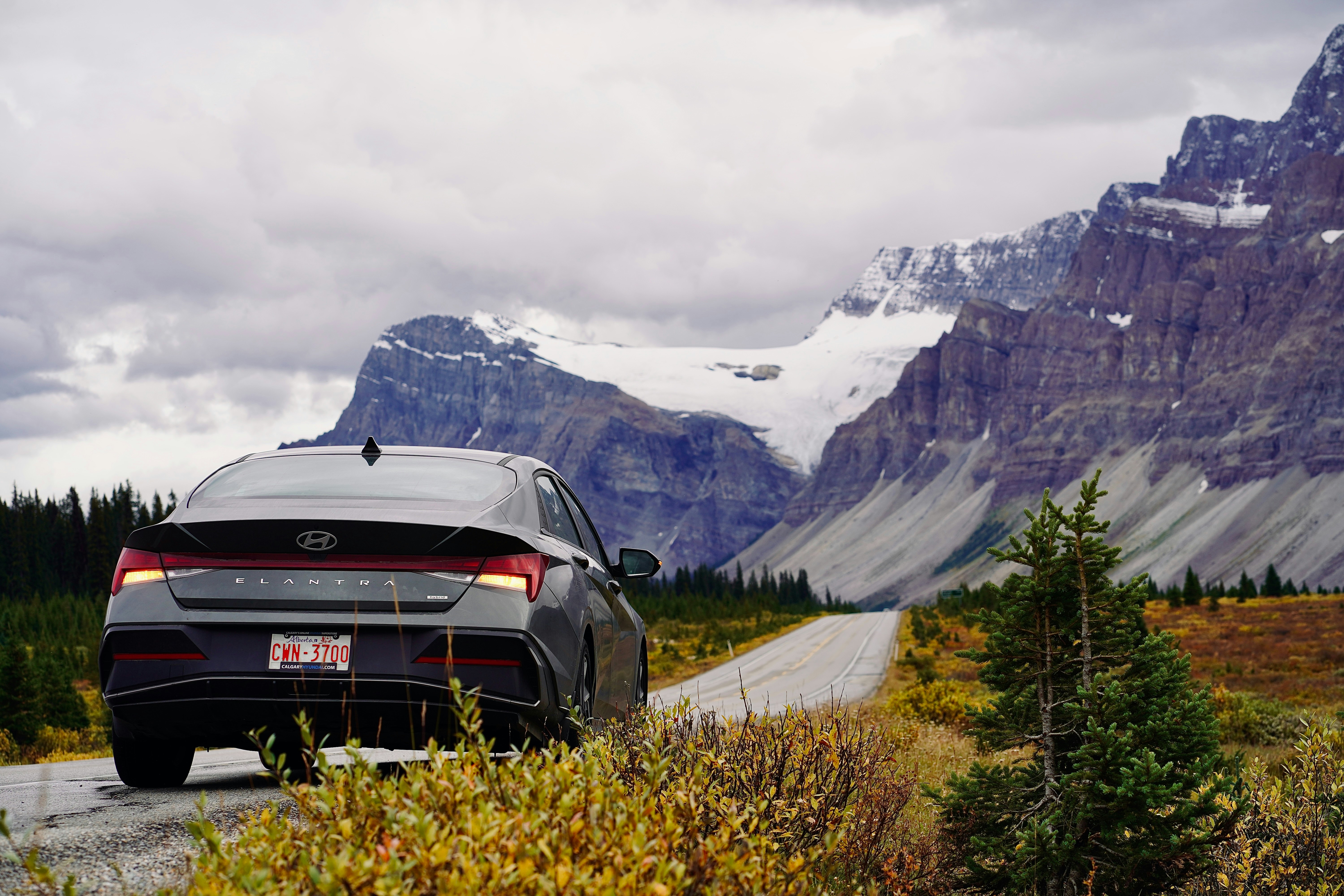 Deserted Highway Sonata: A Hyundai Stretched Across a Mountain Corridor