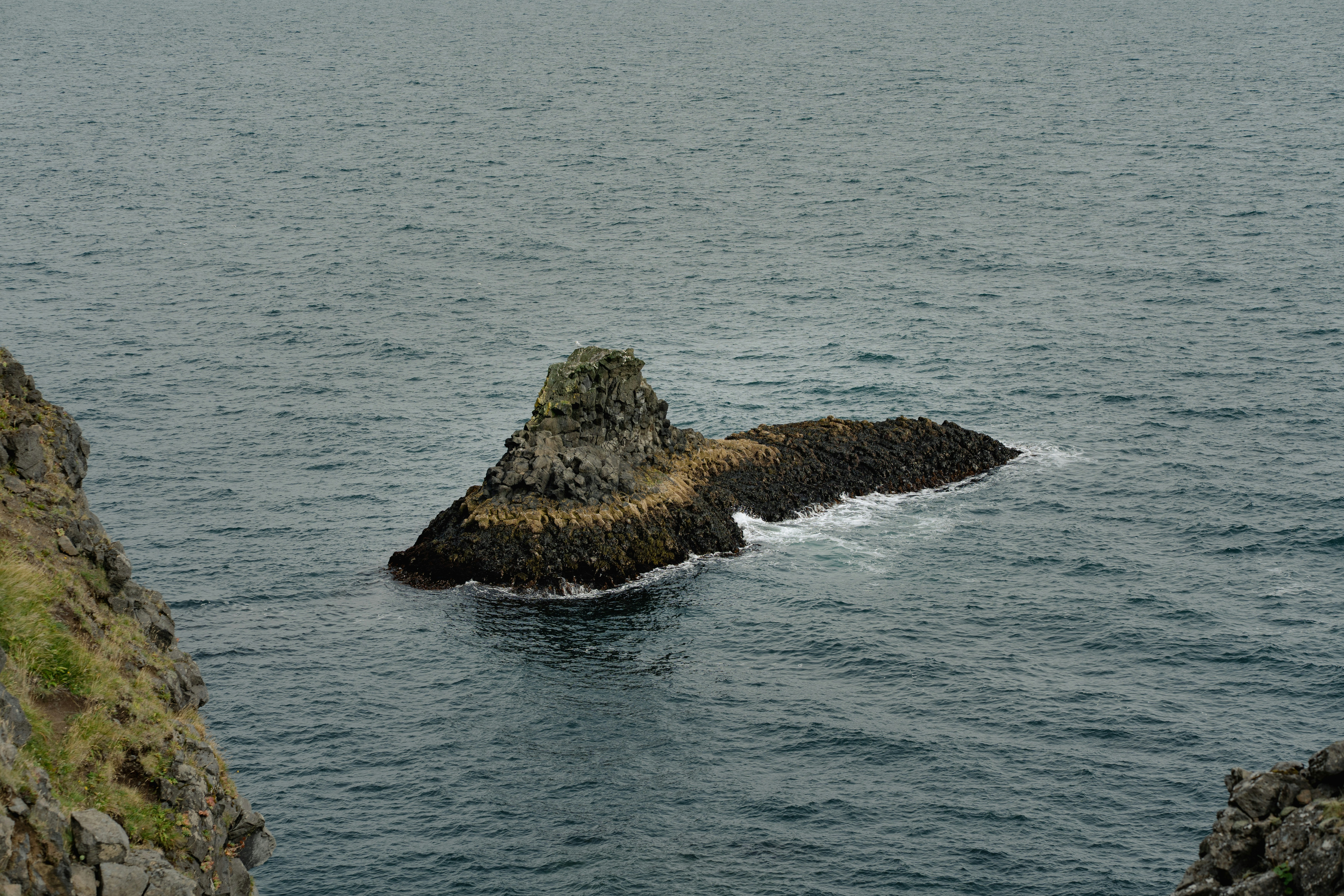 Isolated Rock Sentinel in a Quiet Sea