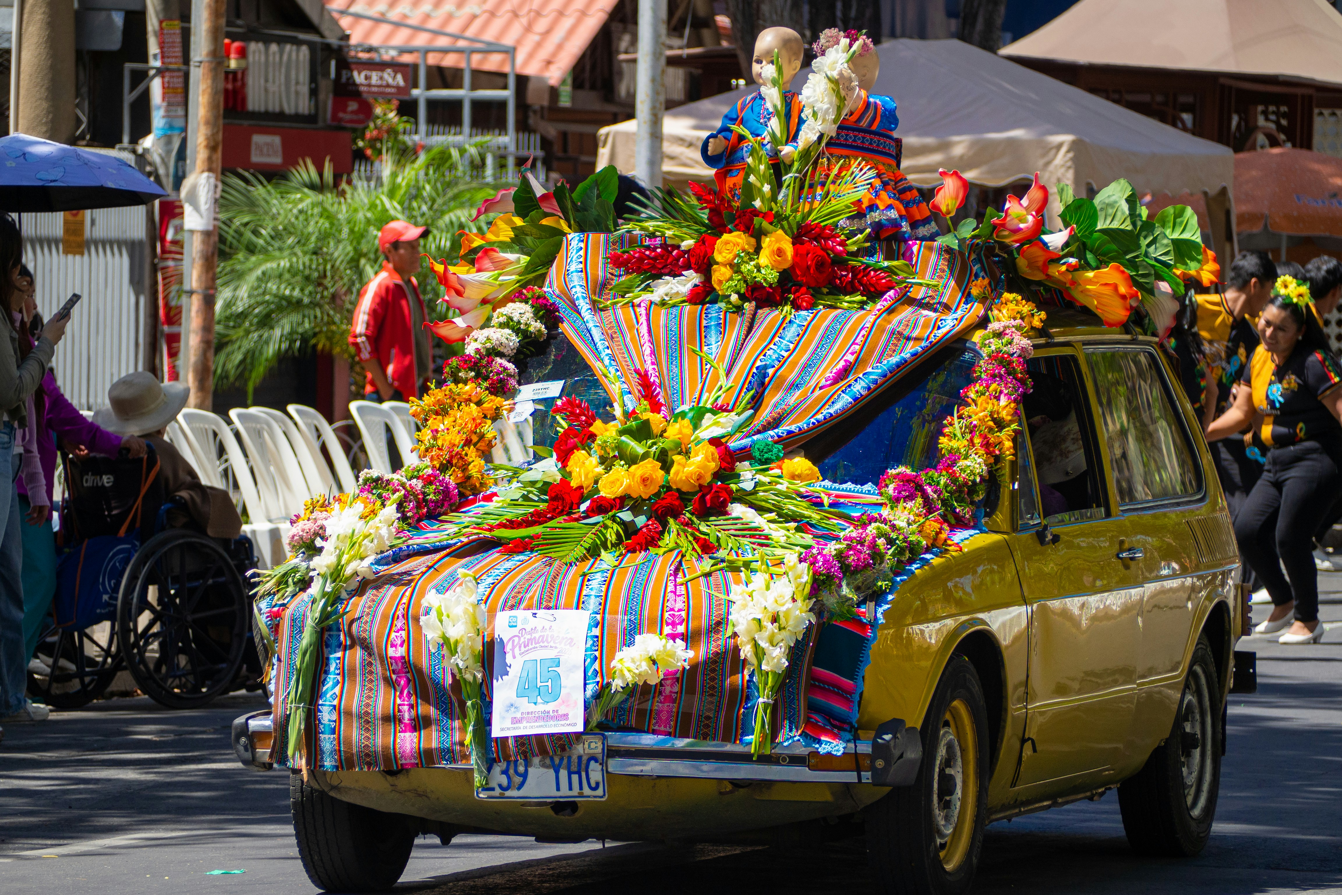 Floral Parade: A Festively Adorned Wagon Leads the Street