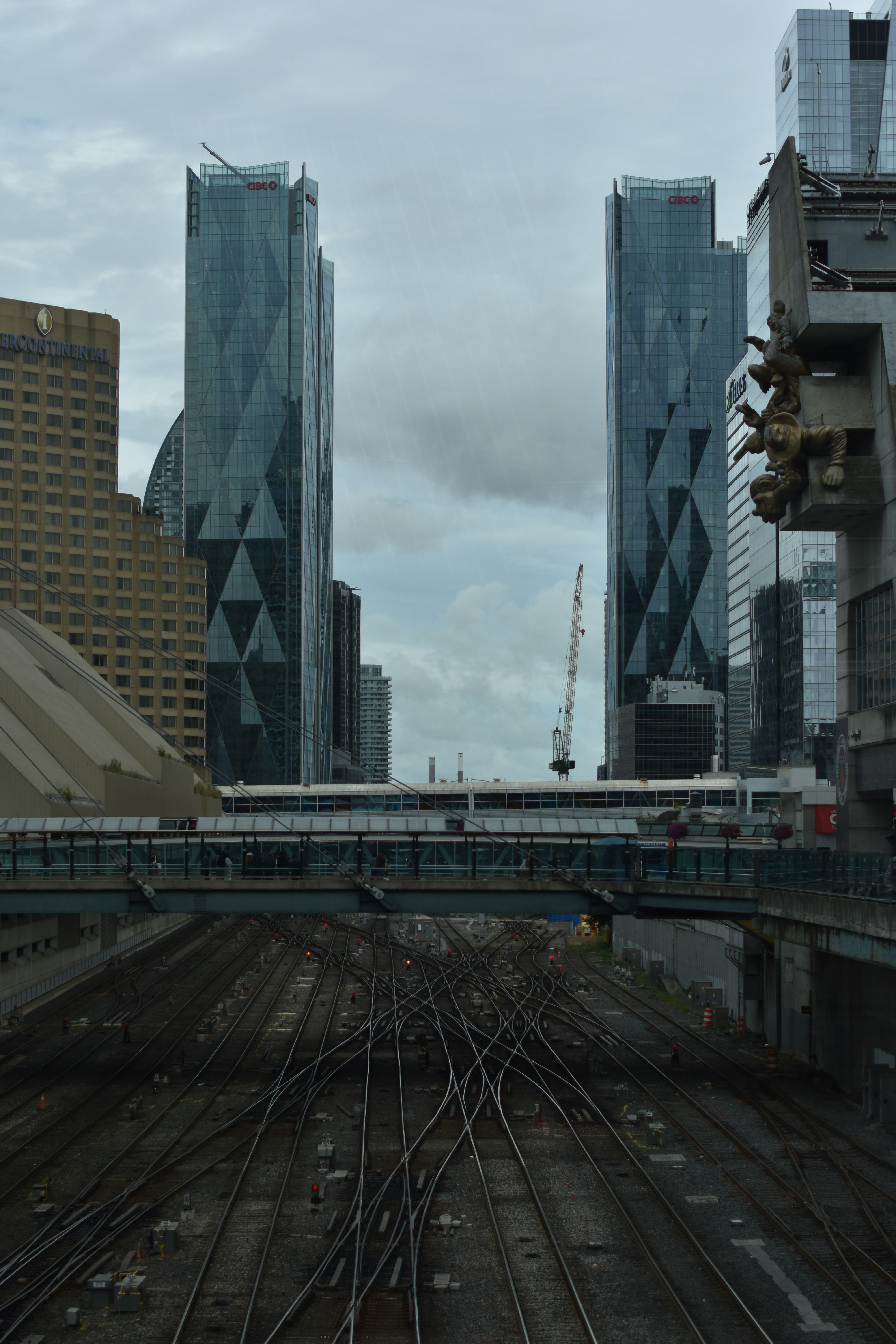 Urban Rails: A Cityscape Framed by Skyward Glass and Tangled Tracks
