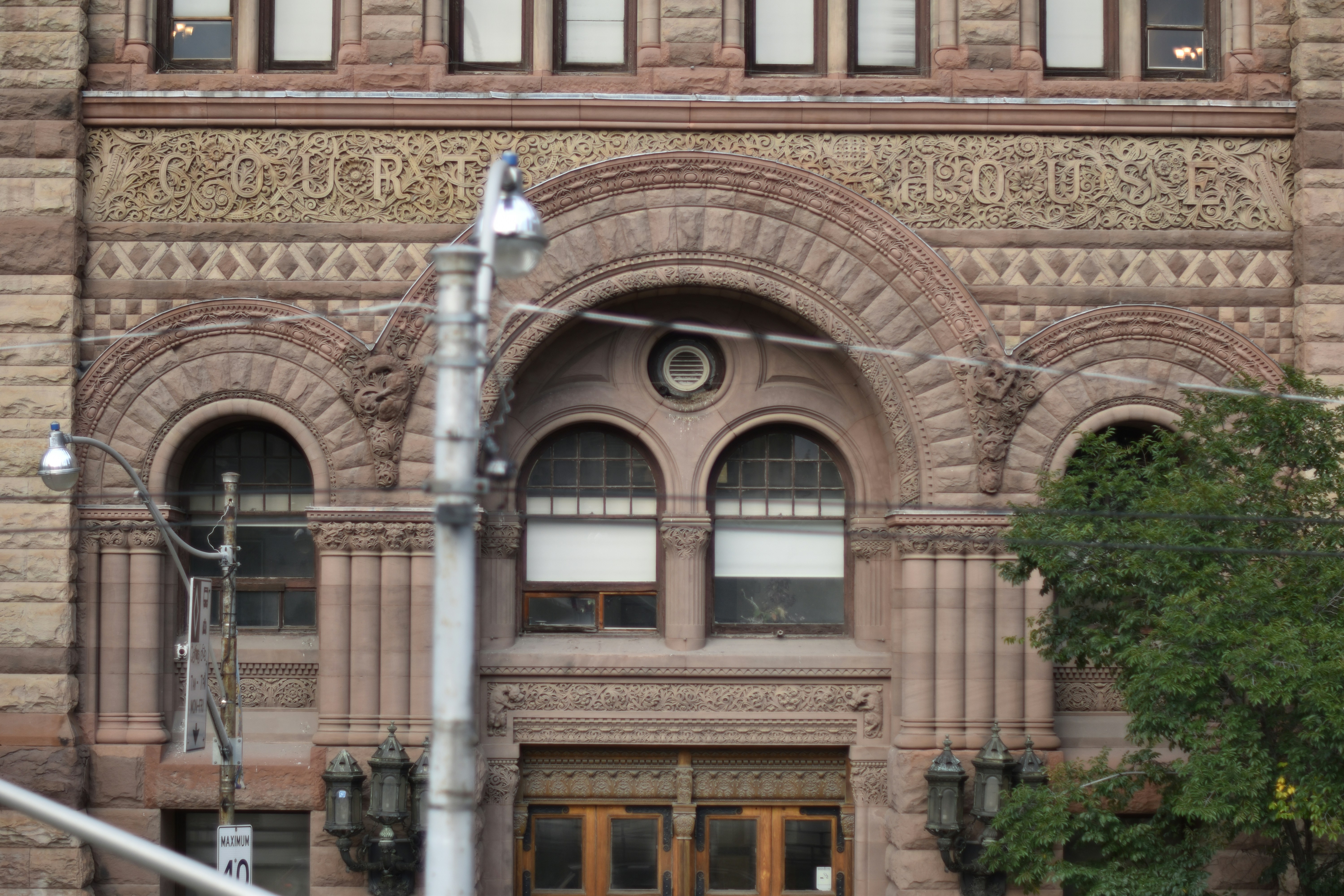 Ornate Romanesque Facade: Arched Entryway with Cresting Details