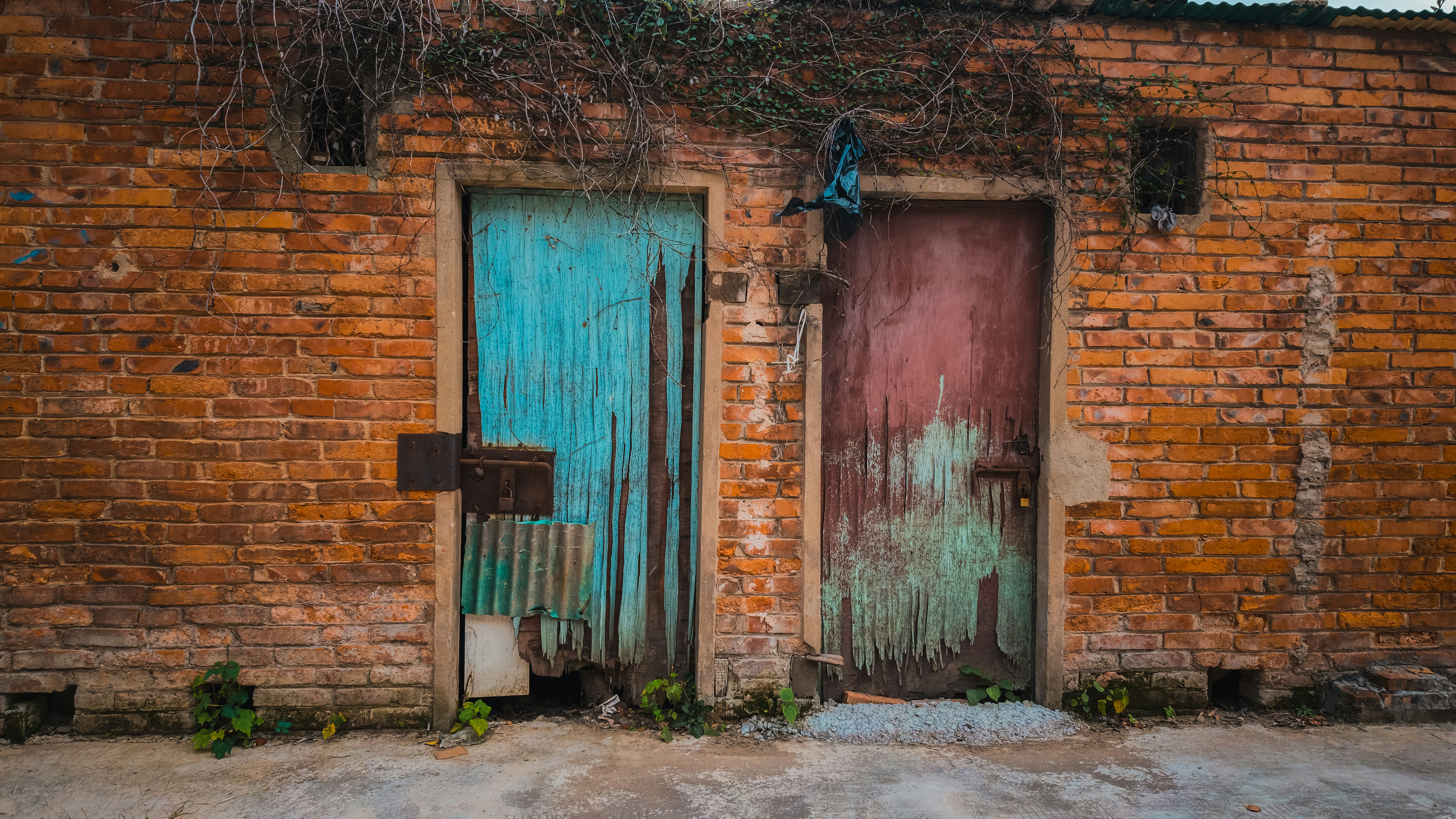 Weathered Doors Against a Brick Wall: Quiet Decay of a Back Alley